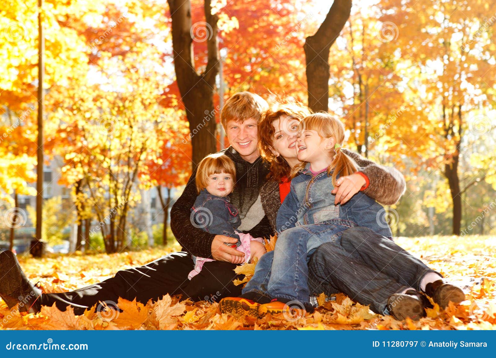 Family on autumn leaves stock image. Image of park, autumnal - 11280797