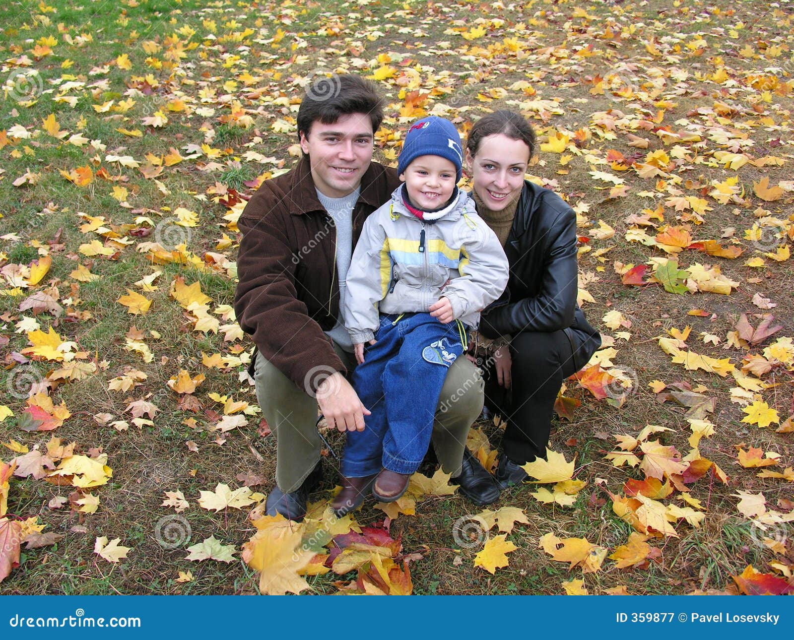 Family on autumn leaves stock image. Image of mommy, father - 359877