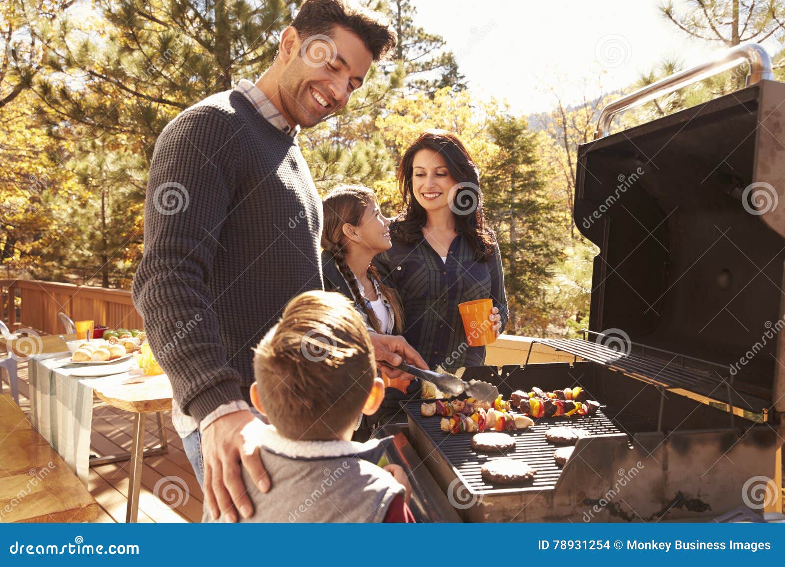 Family Barbecuing on a Deck in the Forest Stock Photo - Image of ...
