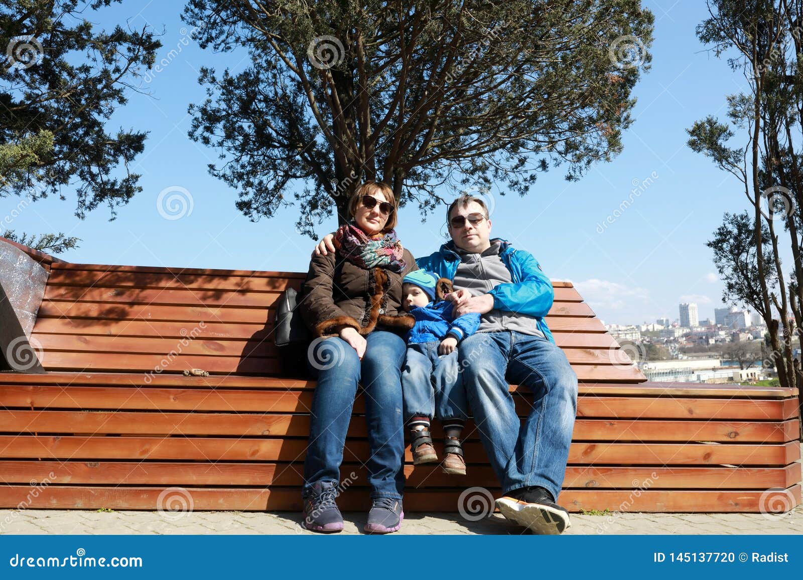 Family on bench in spring stock photo. Image of leisure - 145137720