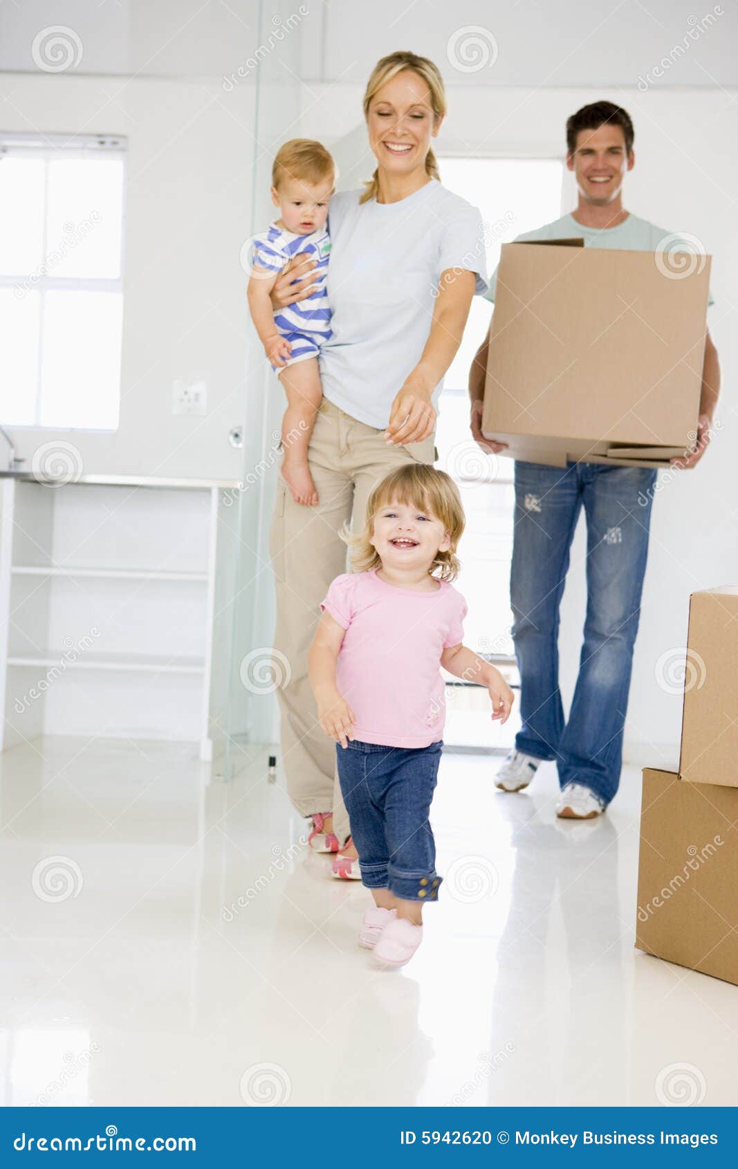 Family with Box Moving into New Home Smiling Stock Photo - Image of ...
