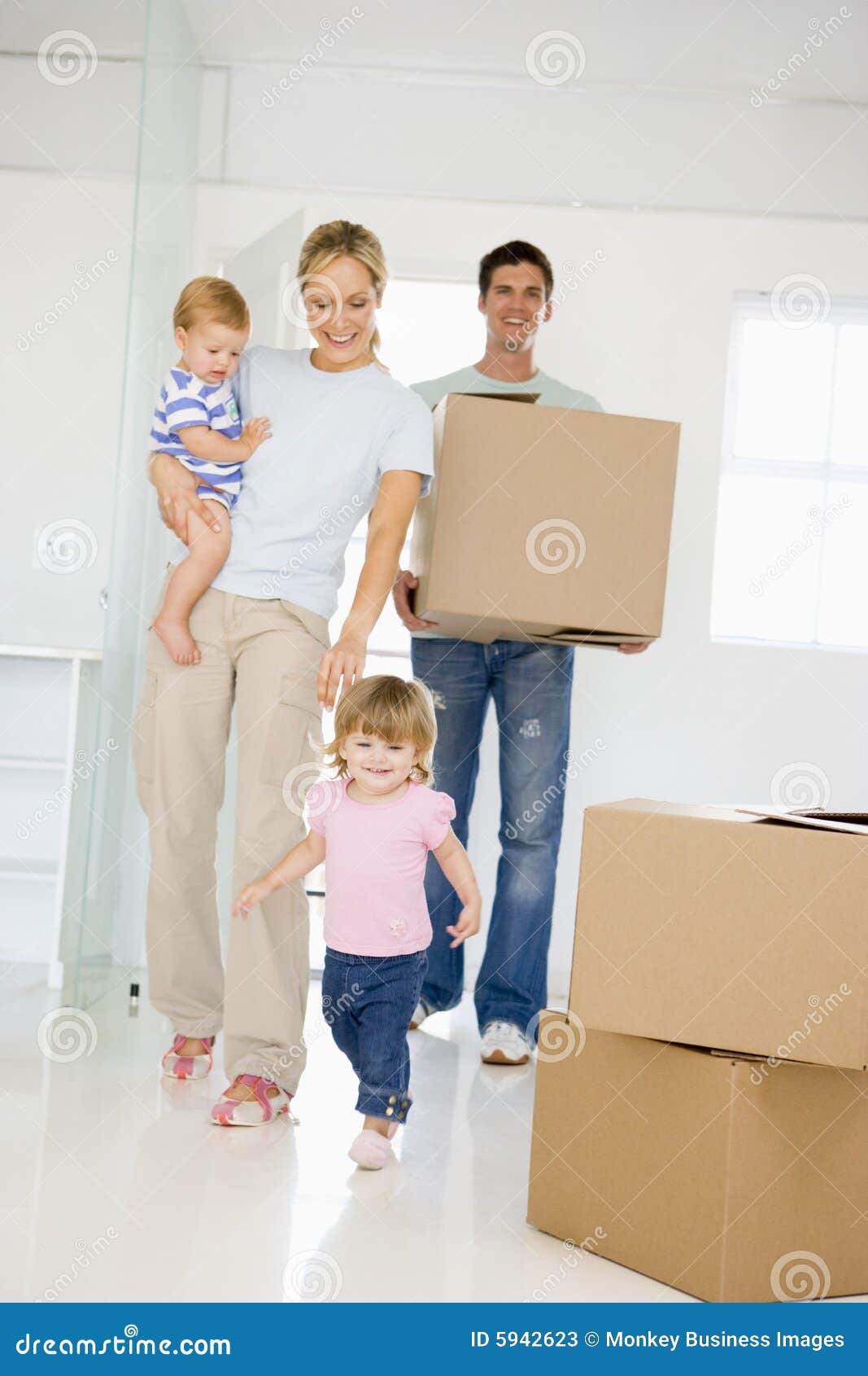 Family with Box Moving into New Home Smiling Stock Image - Image of ...