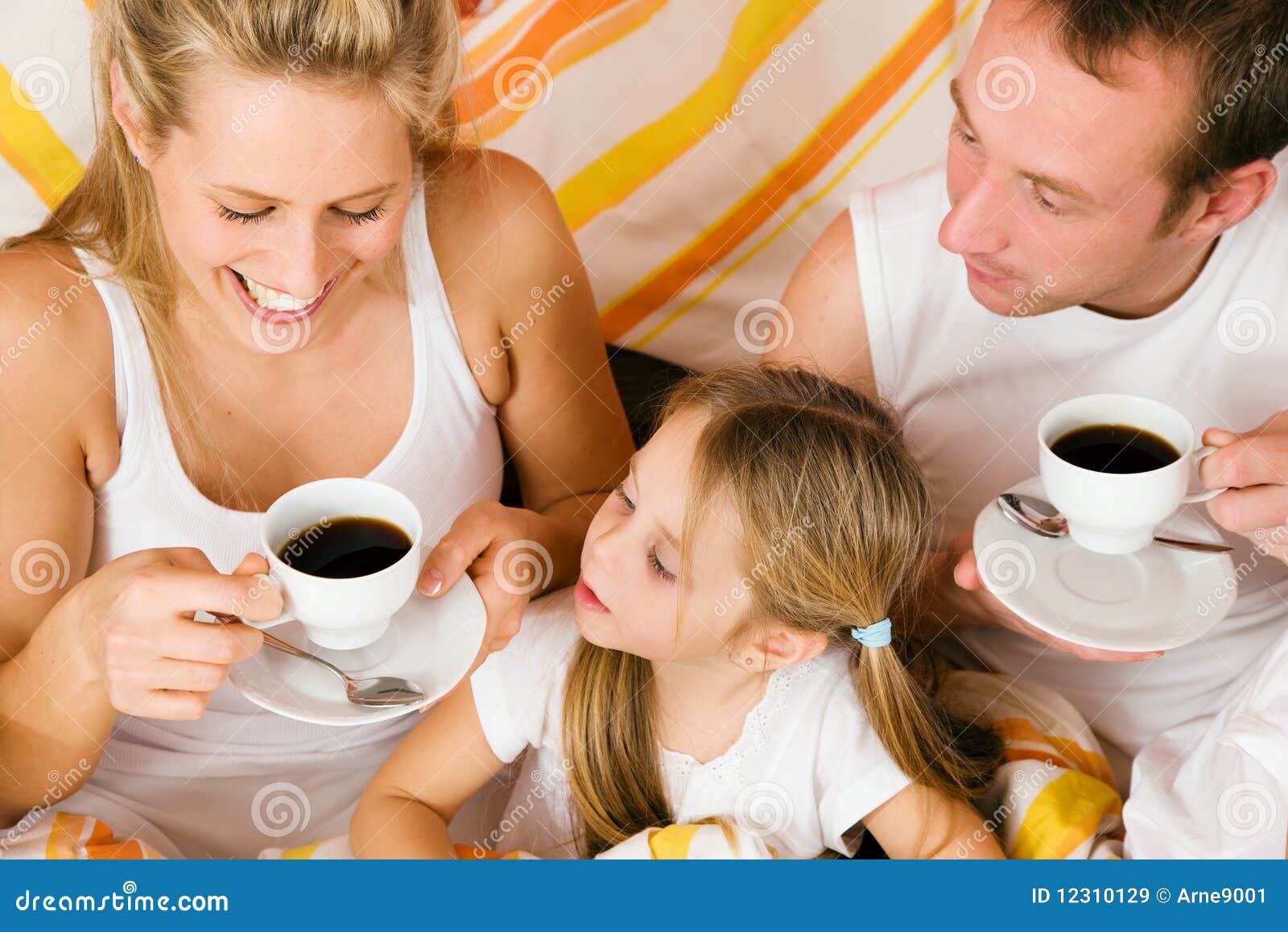 Family breakfasting in bed stock image. Image of father - 12310129