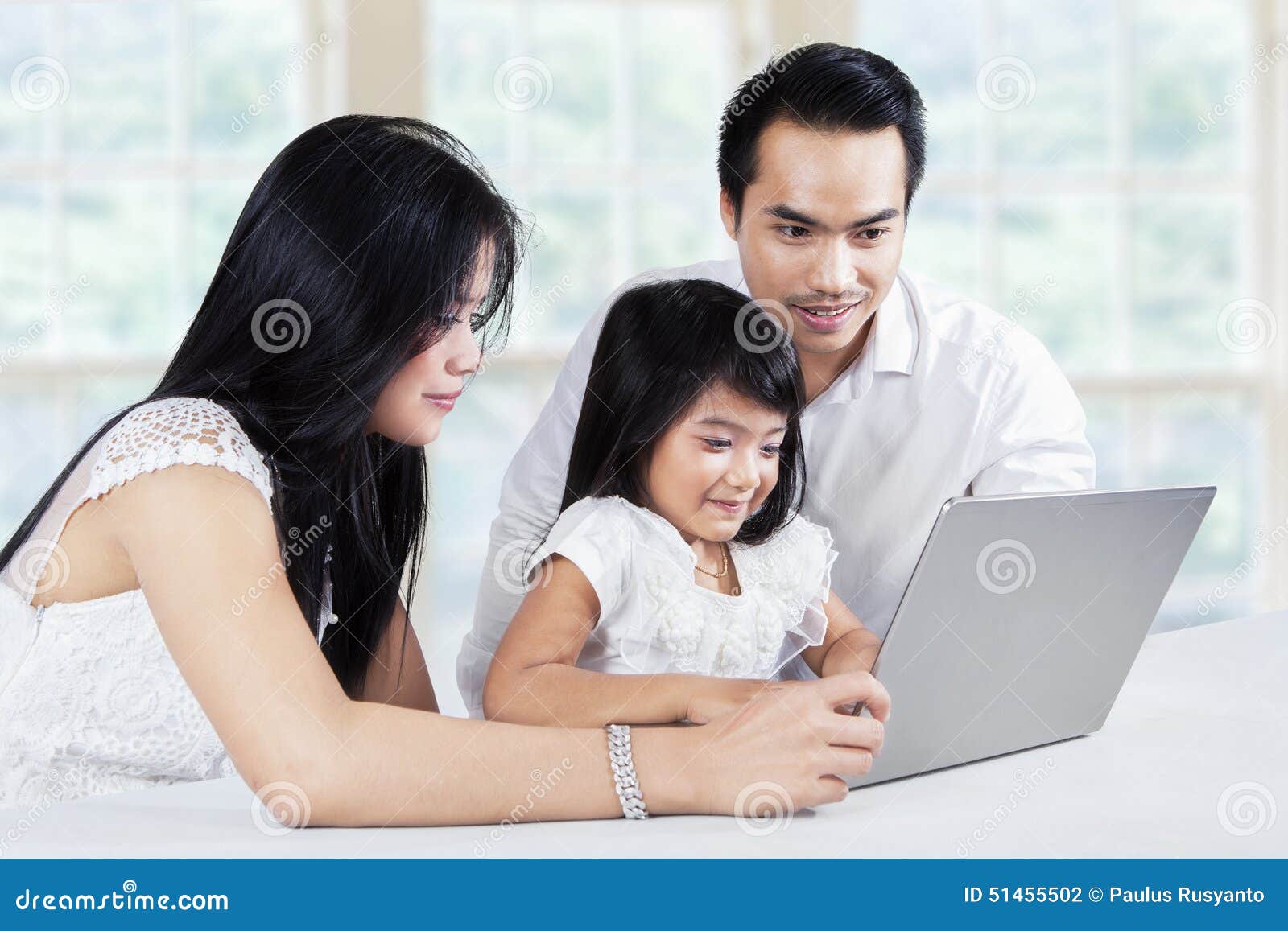 Family Browsing Internet with Laptop on Table Stock Photo - Image of ...