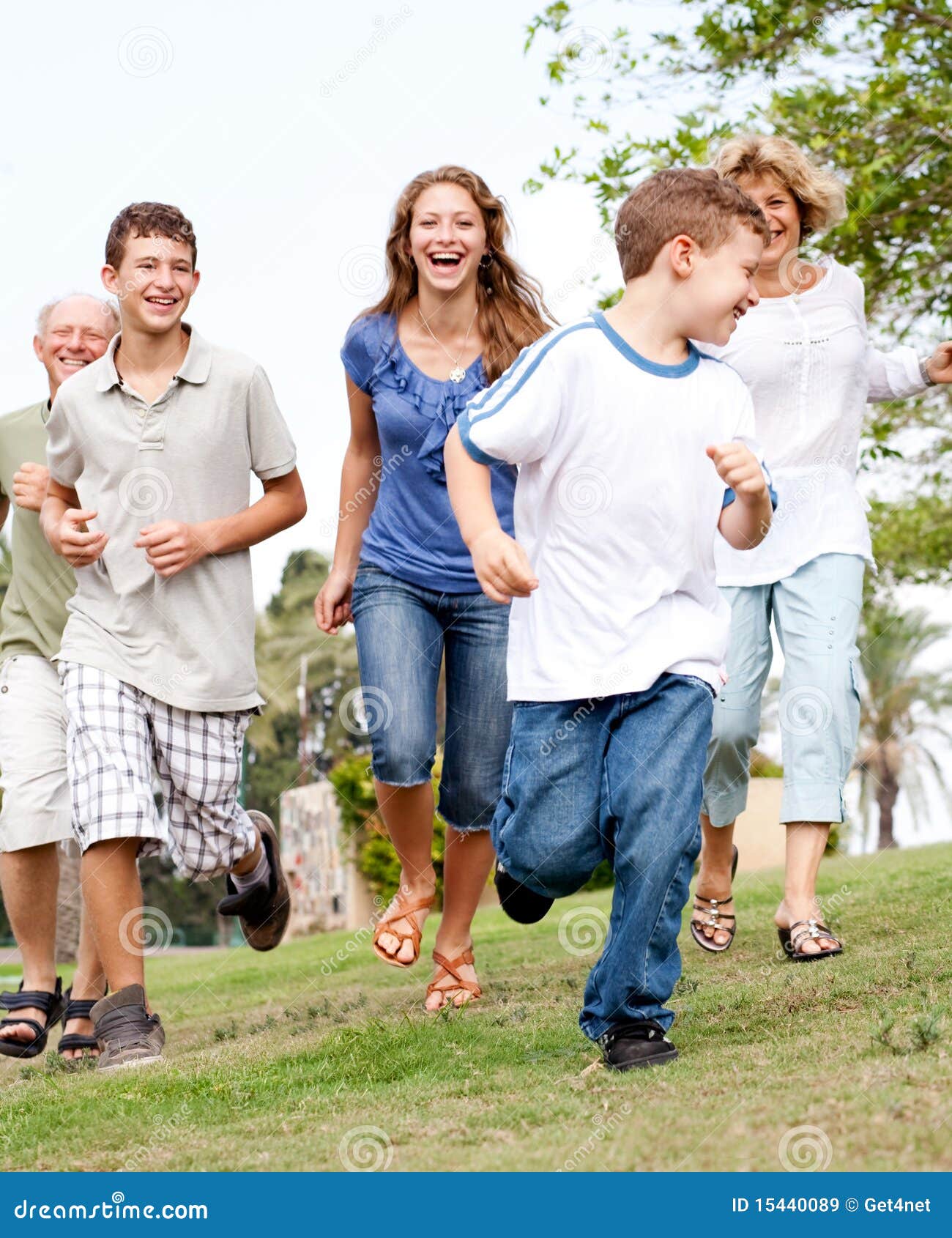 Family Chasing Young Kid in the Park Stock Image - Image of loving ...