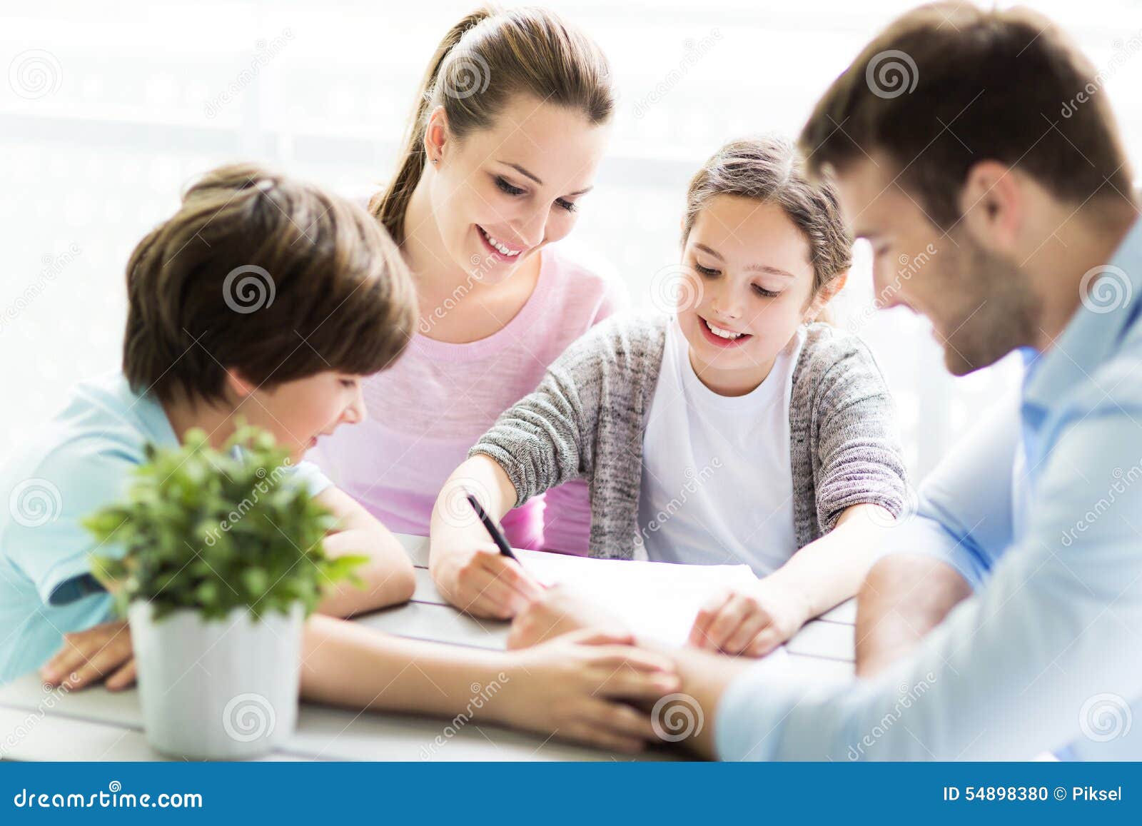 Family Doing Homework Together at Table Stock Photo - Image of daughter ...