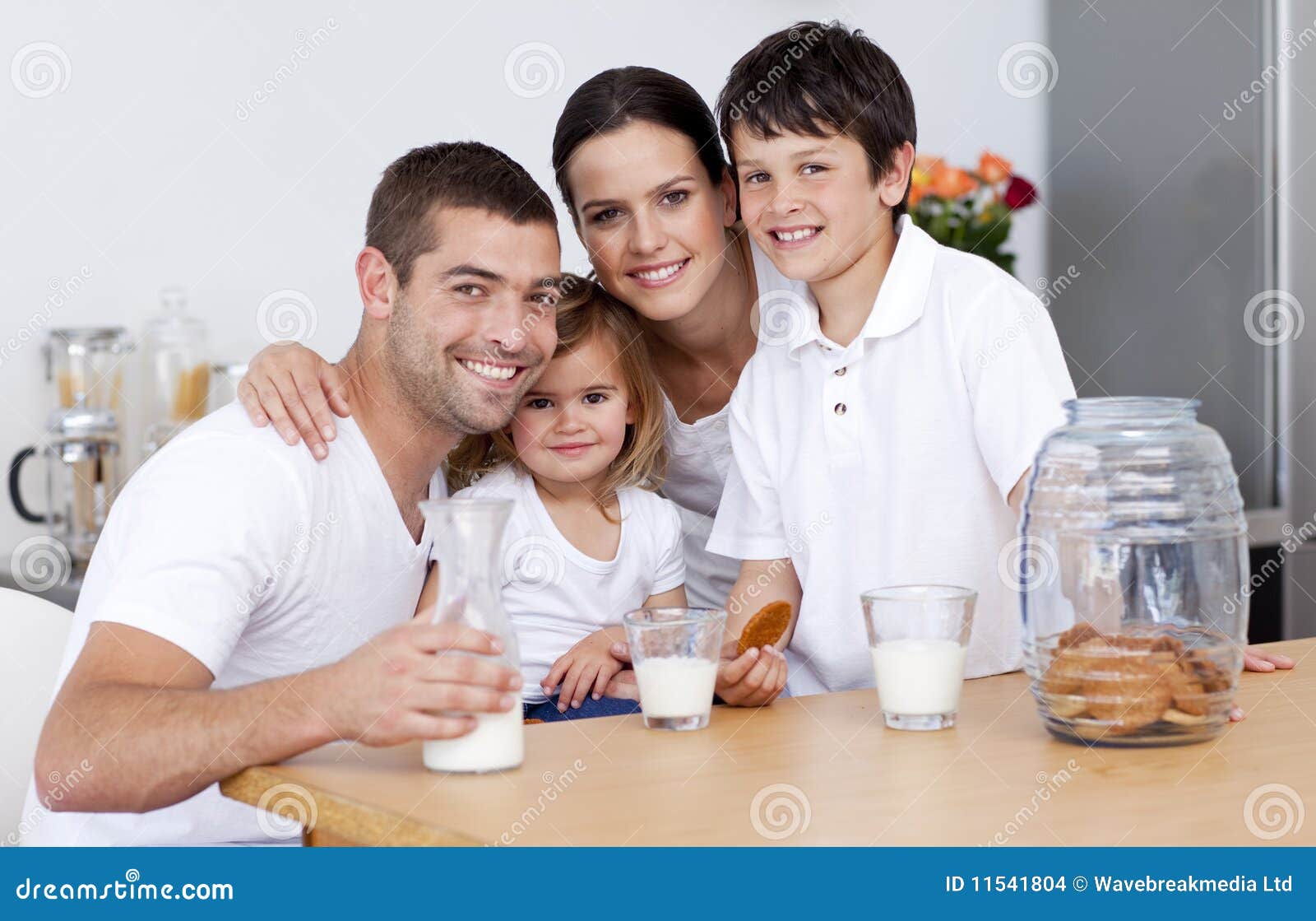 Family Eating Biscuits and Drinking Milk Stock Photo - Image of girl ...