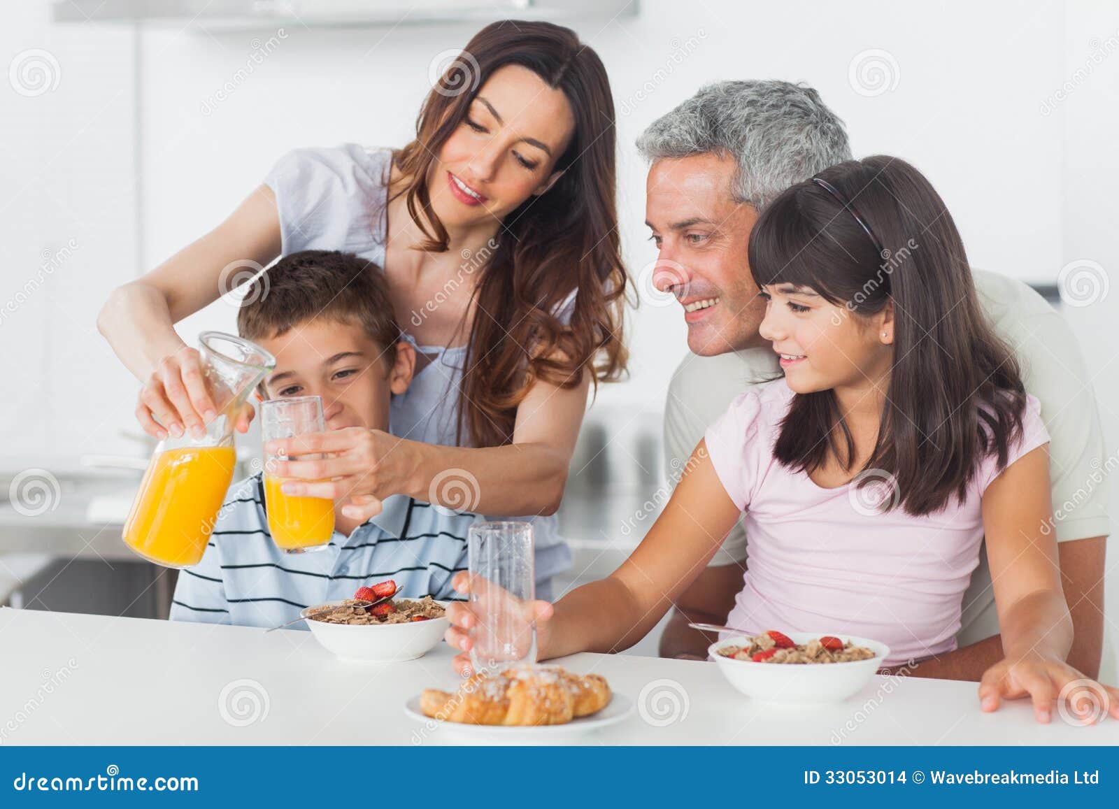Family Eating Breakfast in Kitchen Together Stock Photo - Image of ...
