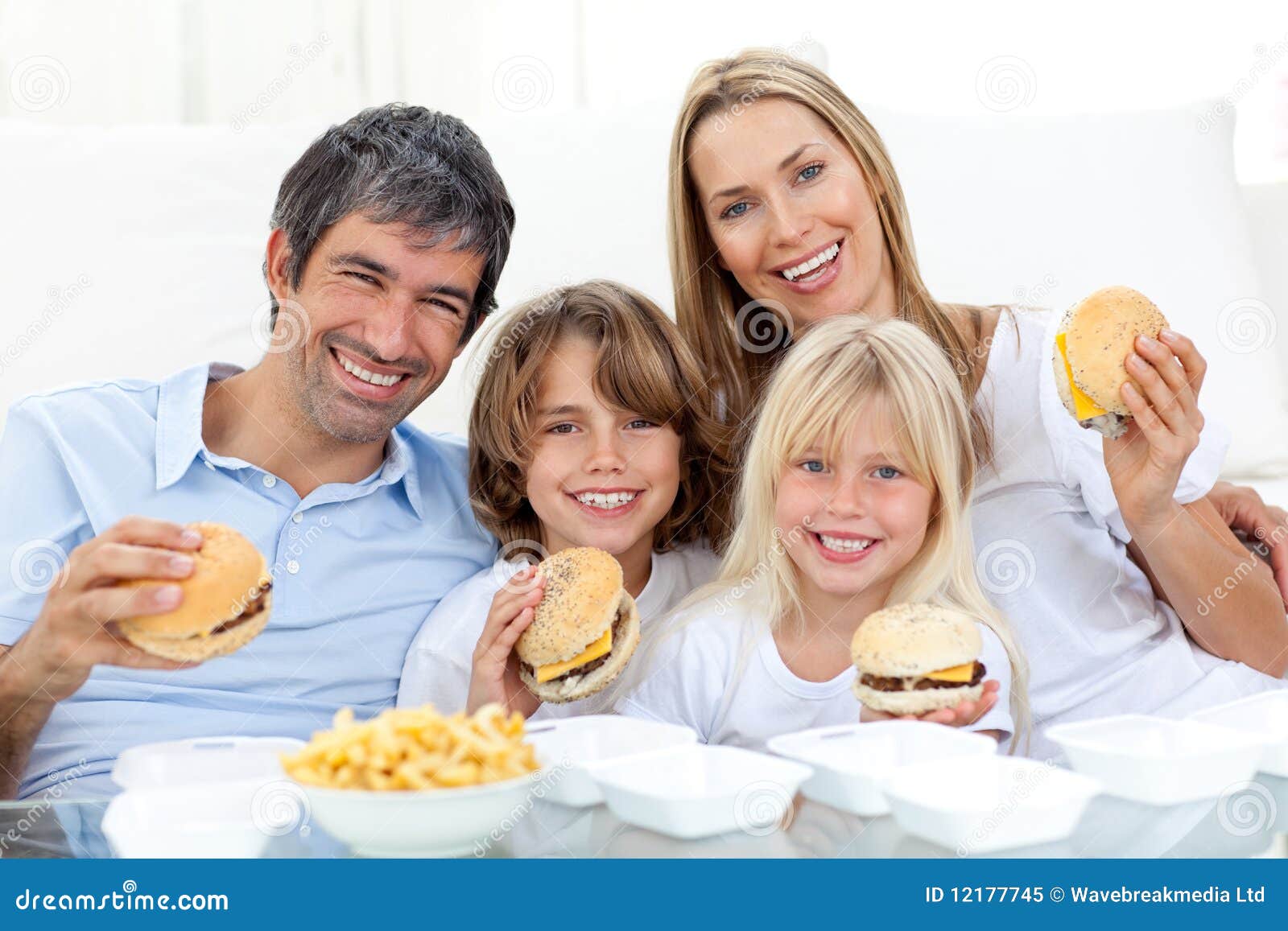 Family eating hamburgers stock image. Image of home, person - 12177745