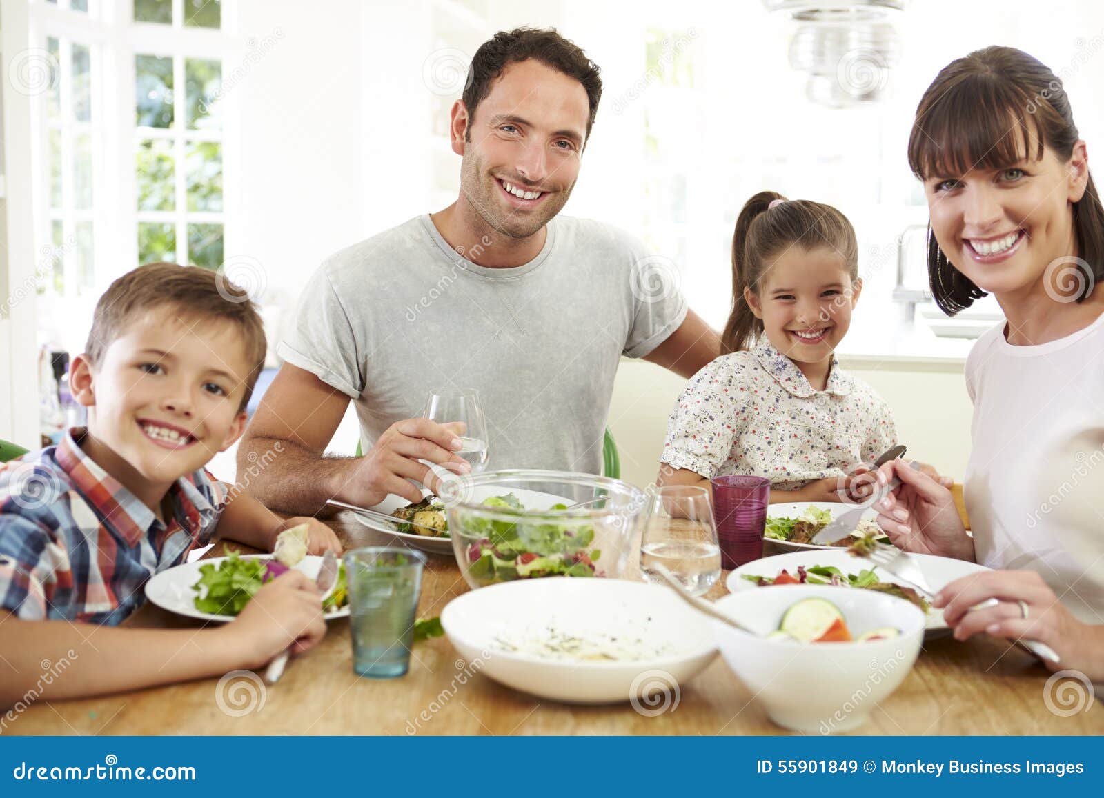 Family Eating Meal Around Kitchen Table Together Stock Image - Image of ...