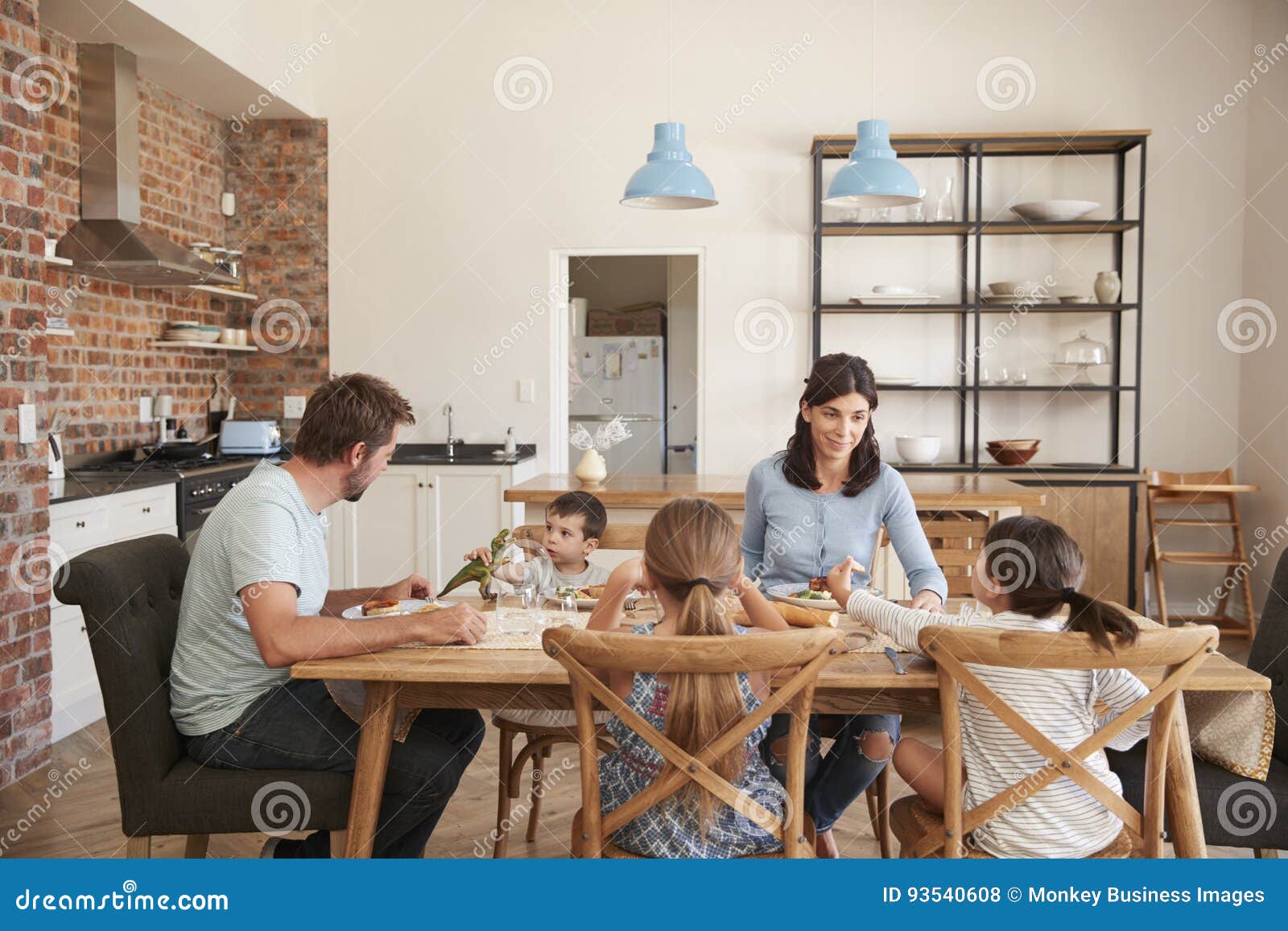 Family Eating Meal in Open Plan Kitchen Together Stock Photo - Image of ...