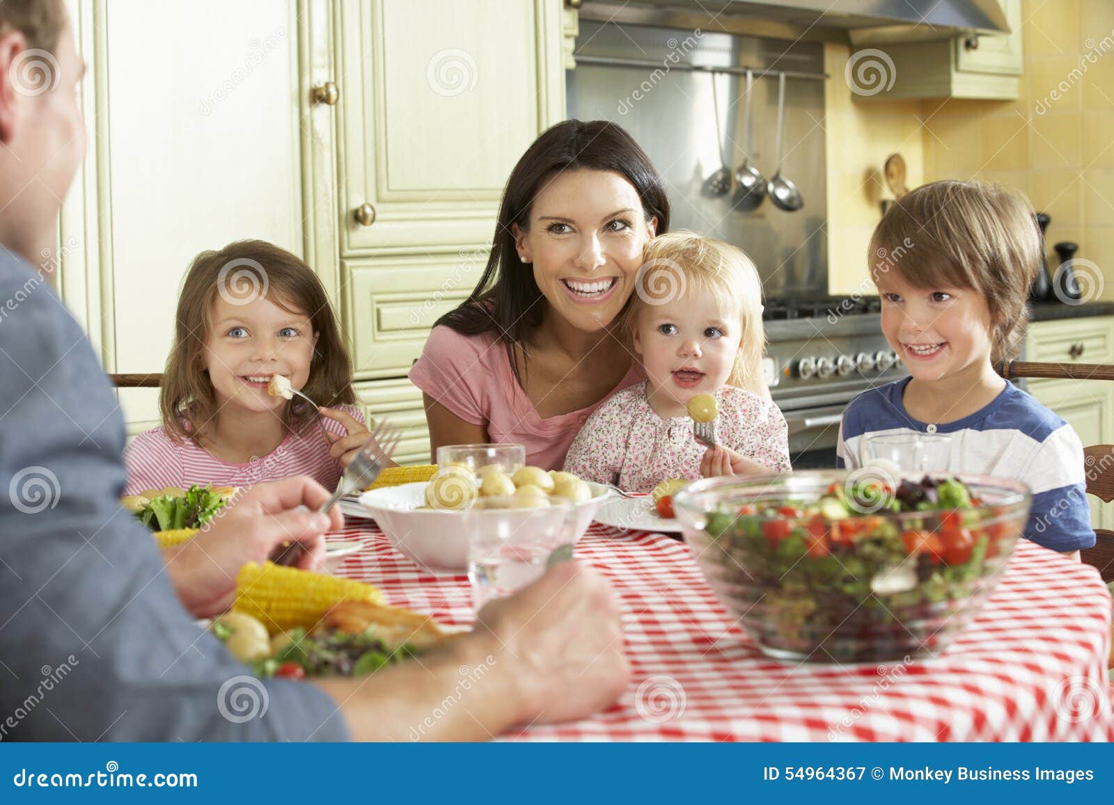 Family Eating Meal Together in Kitchen Stock Image - Image of children ...