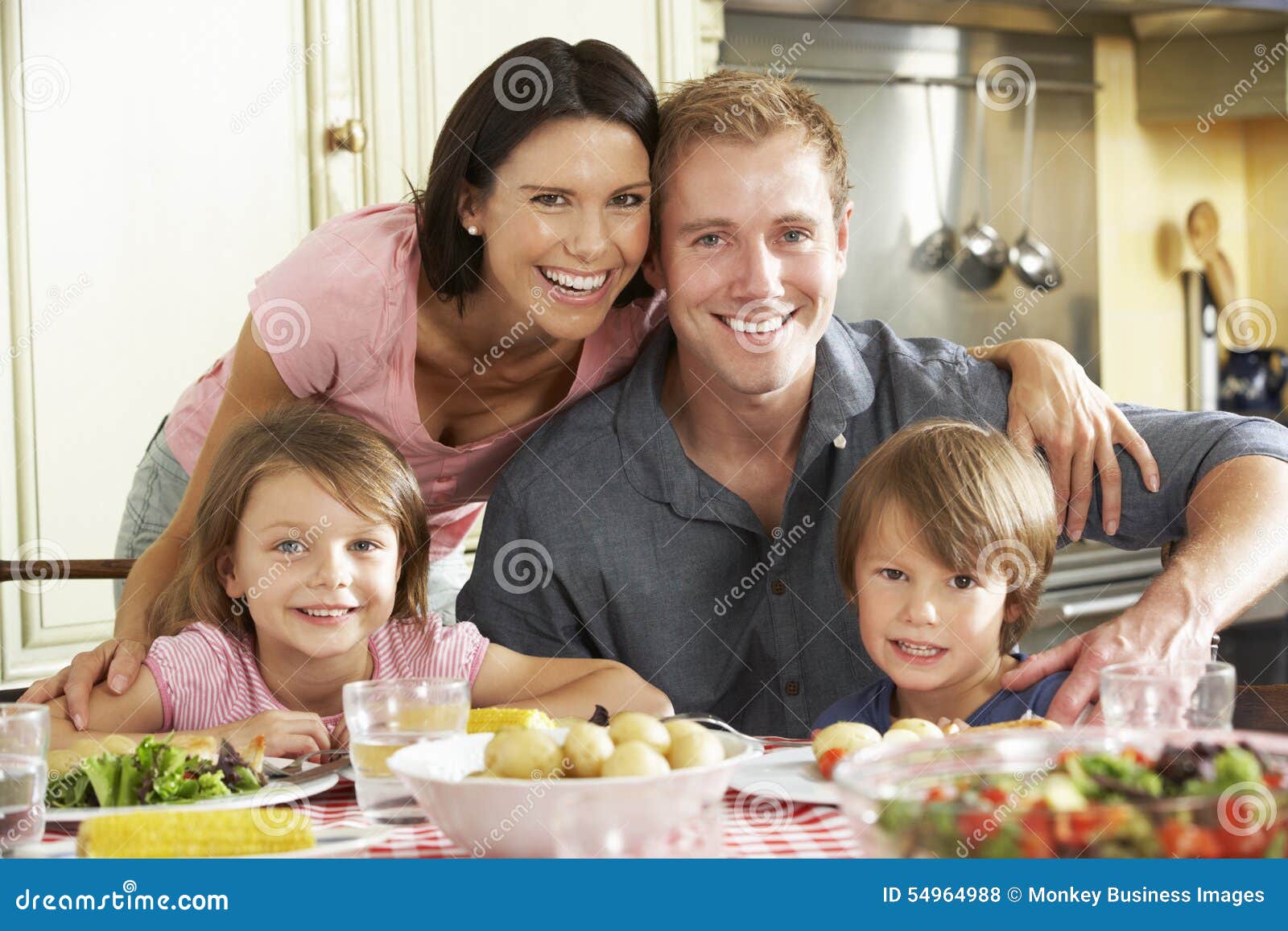 Family Eating Meal Together in Kitchen Stock Photo - Image of happy ...