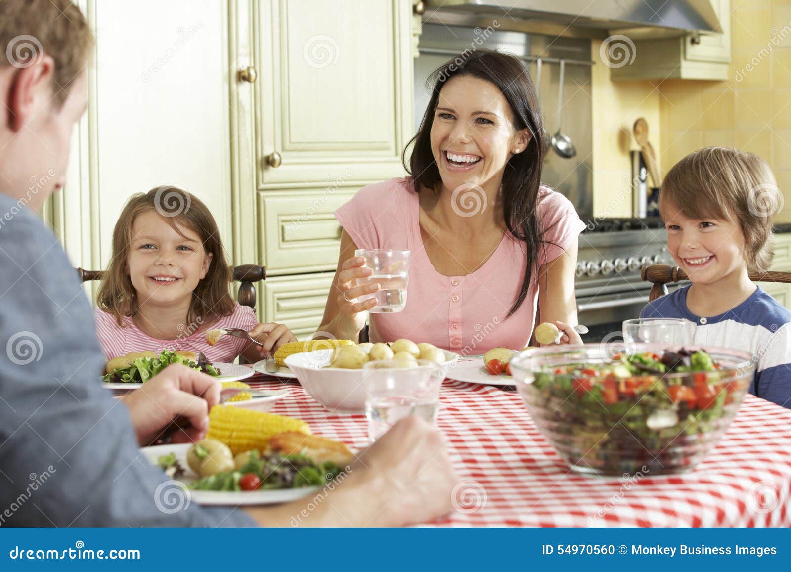 Family Eating Meal Together in Kitchen Stock Photo - Image of smiling ...