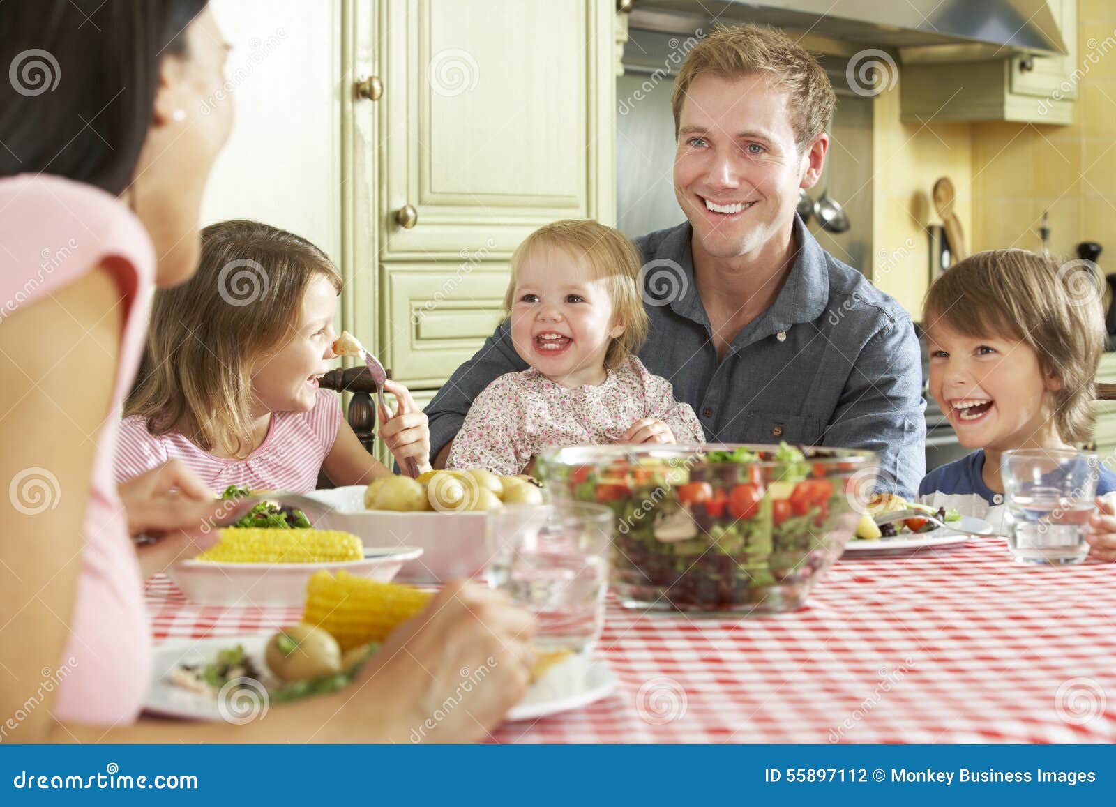 Family Eating Meal Together in Kitchen Stock Photo - Image of sweetcorn ...