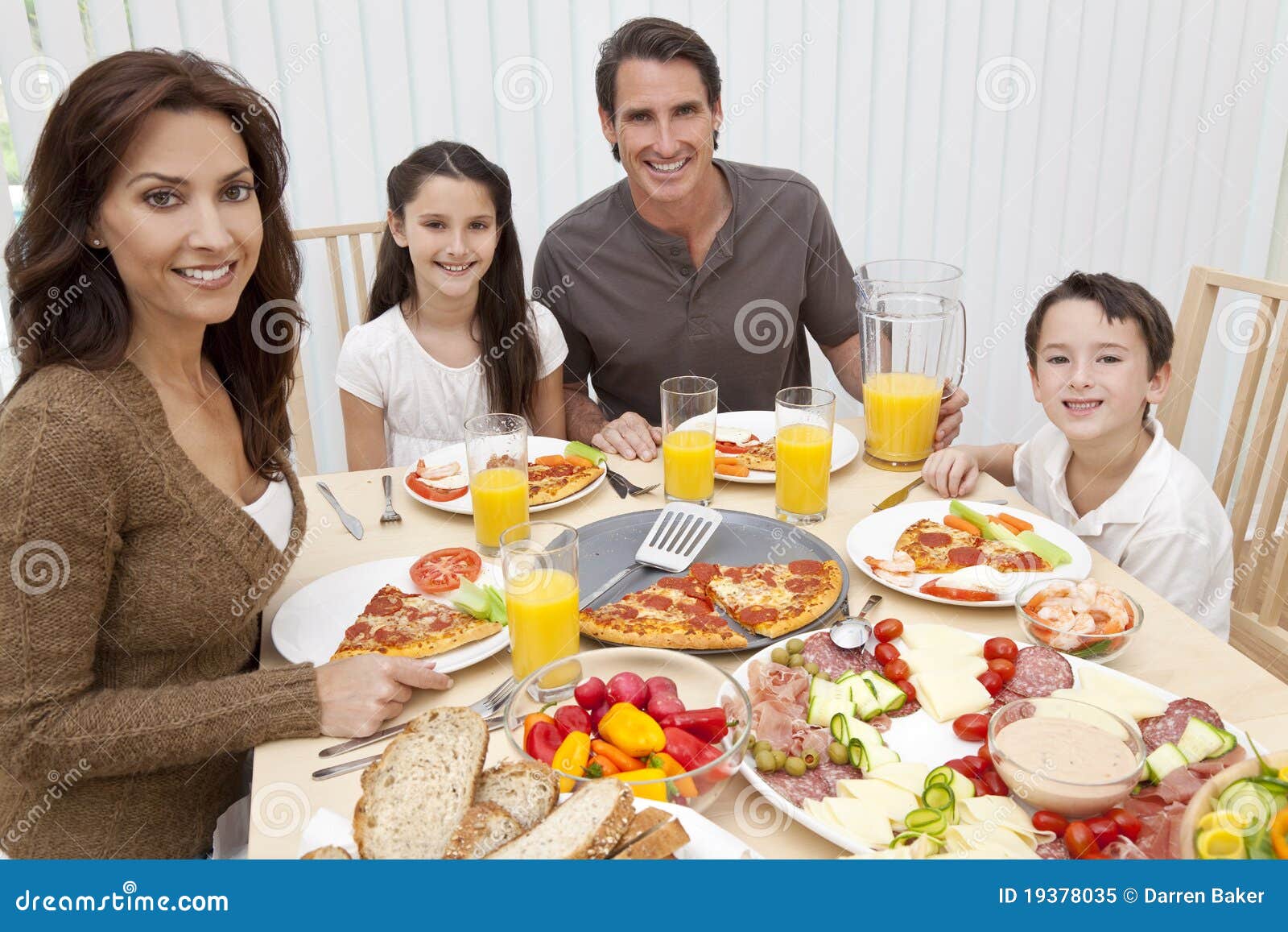 Family Eating Pizza & Salad at Dining Table Stock Image - Image of home ...