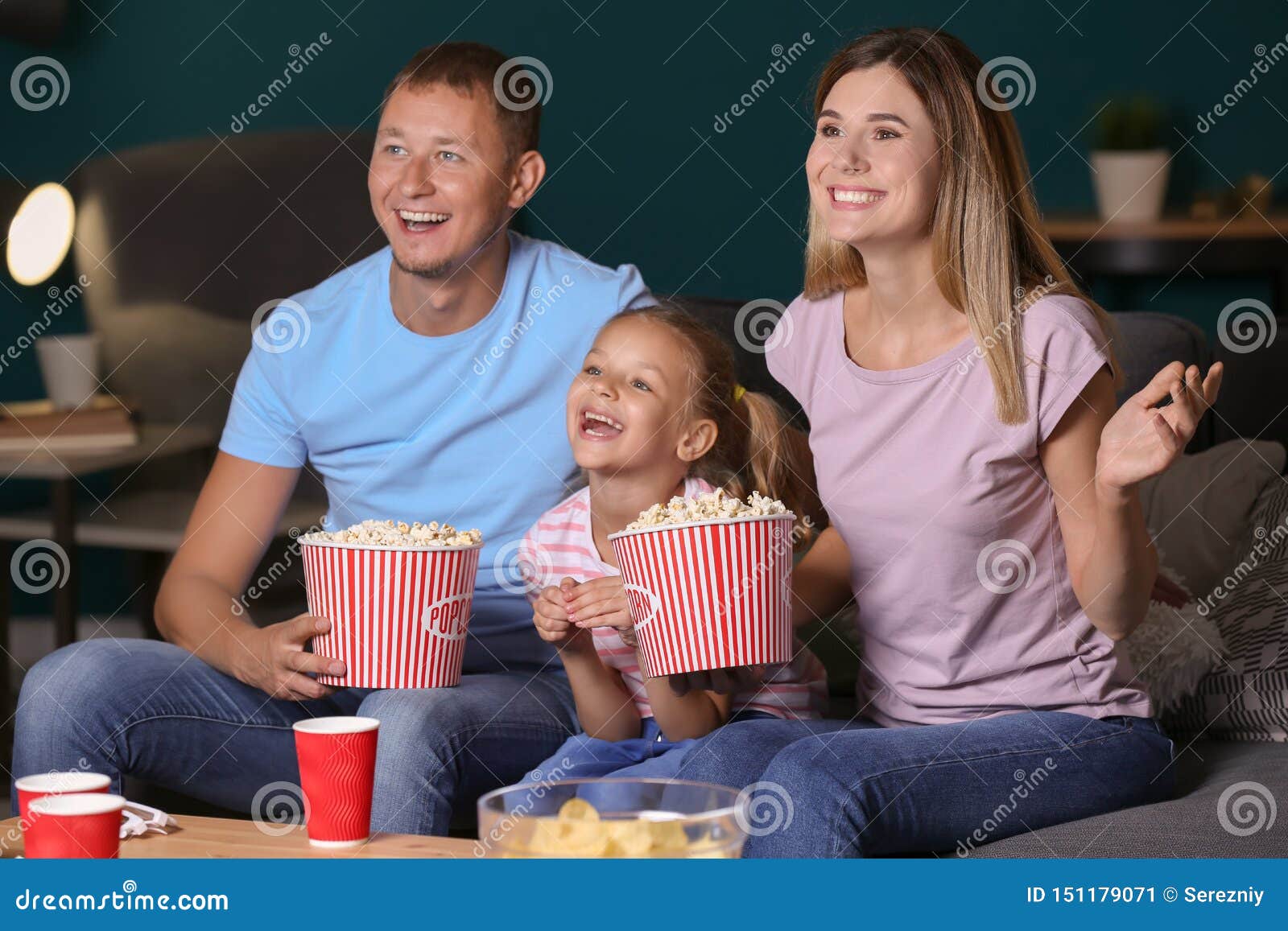 Family Eating Popcorn while Watching TV in Evening Stock Image - Image ...