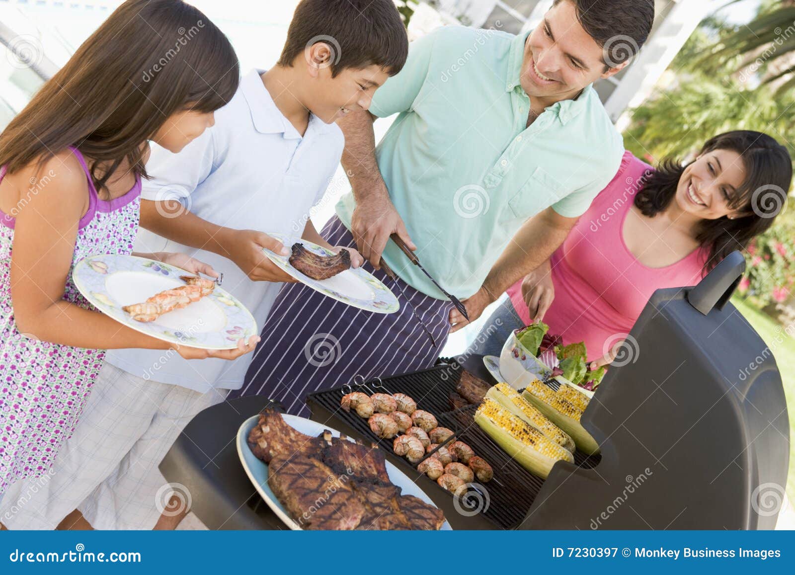 Family Enjoying a Barbeque stock image. Image of hispanic - 7230397