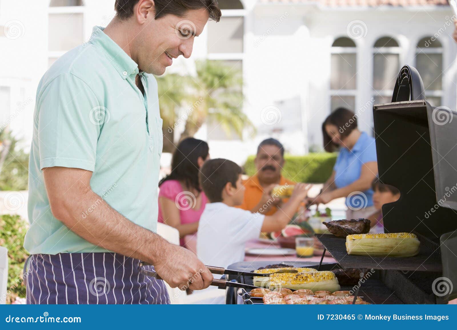 Family Enjoying a Barbeque stock image. Image of home - 7230465