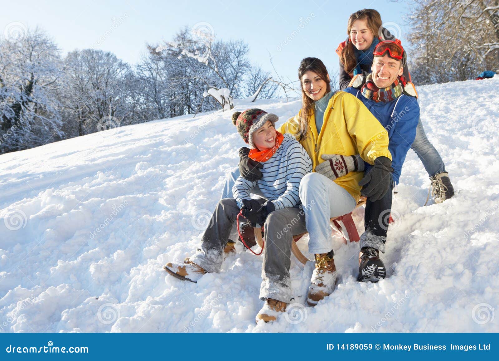 Family Enjoying Sledging Down Snowy Hill Stock Image - Image of four ...