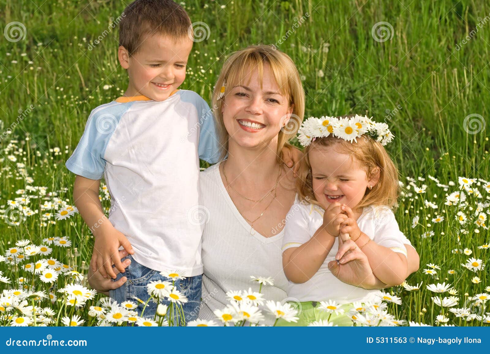 Family among flowers stock image. Image of blond, family - 5311563