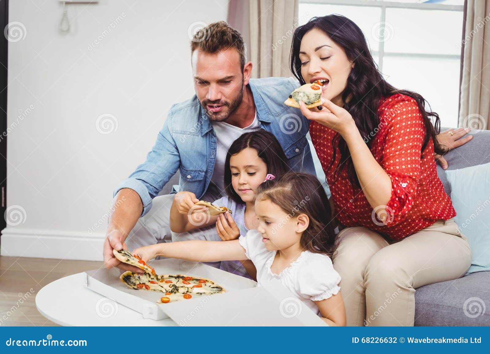 Family of Four Eating Pizza at Home Stock Photo - Image of foreground ...