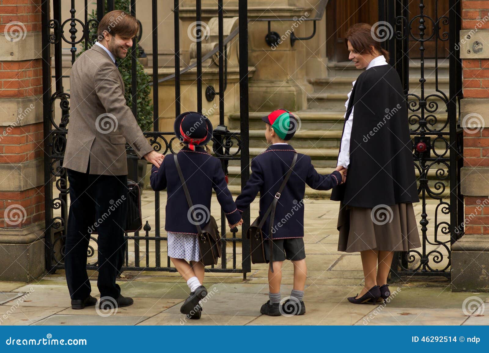 Family of Four Entering Old School Gates Stock Photo - Image of sister ...