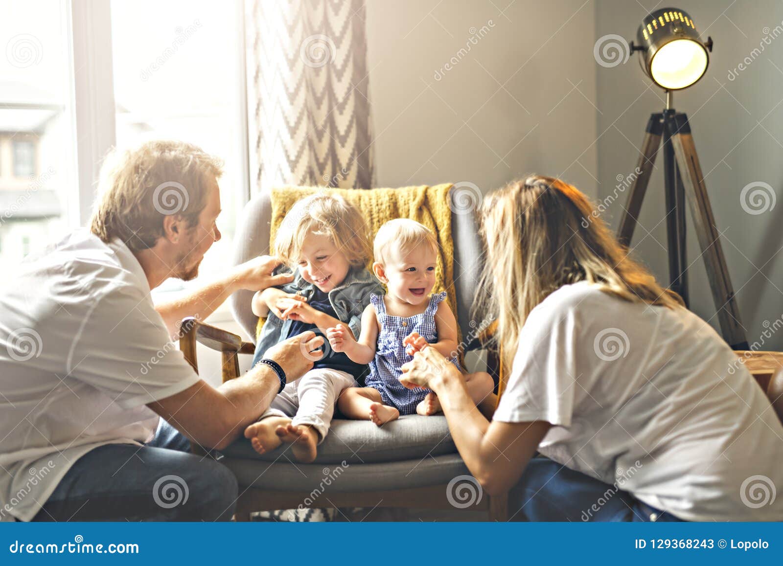 Family having fun on chair stock image. Image of parent - 129368243