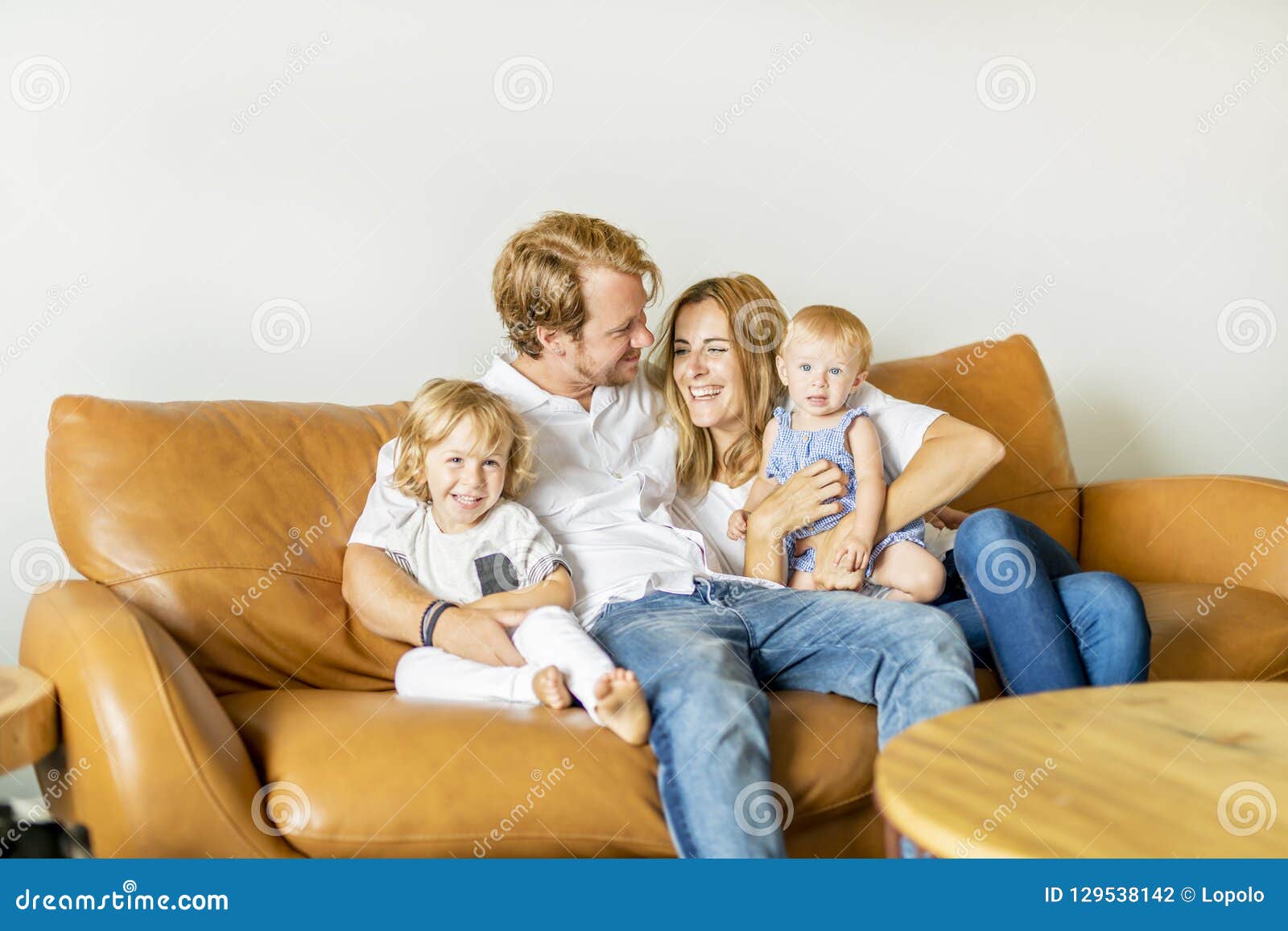 Family having fun on sofa. stock photo. Image of face - 129538142