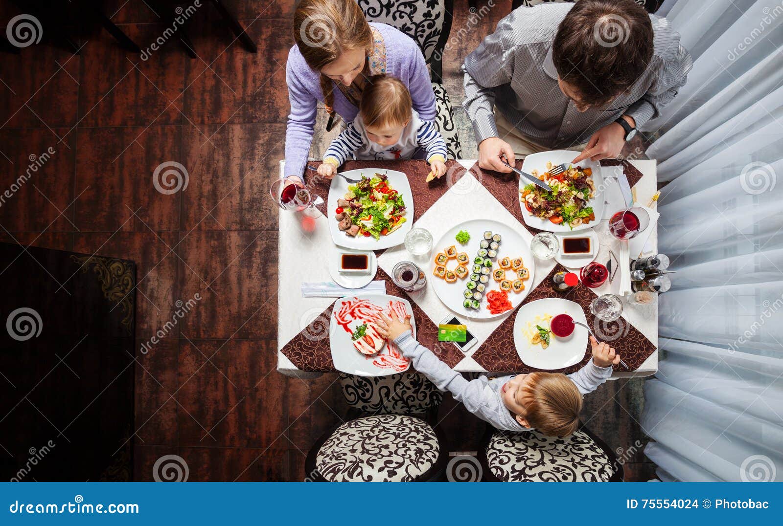 Family of Four Having Meal at a Restaurant Stock Photo - Image of ...