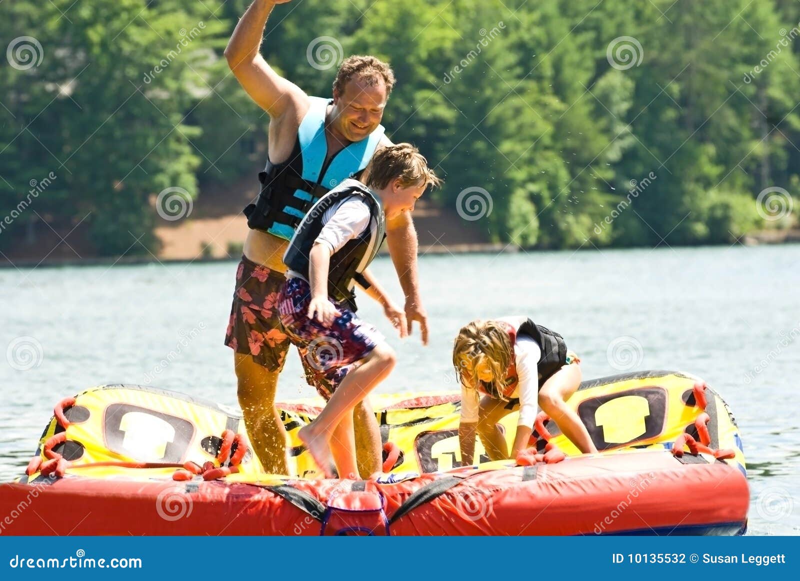 Family Fun on the Lake/Tubing Stock Photo - Image of play, person: 10135532