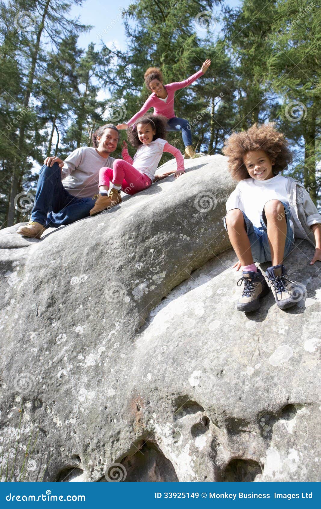 Family Group Sitting on Rock Together Stock Image - Image of people ...