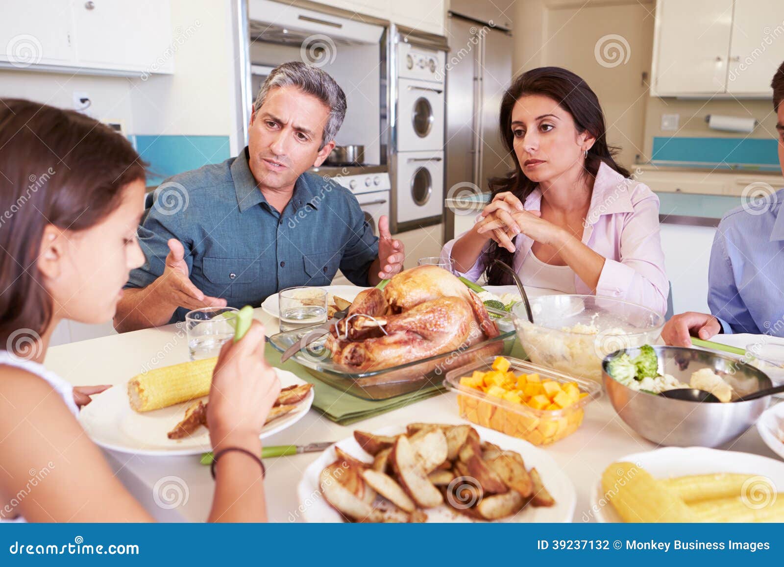 Family Having Argument Sitting Around Table Eating Meal Stock Photo ...