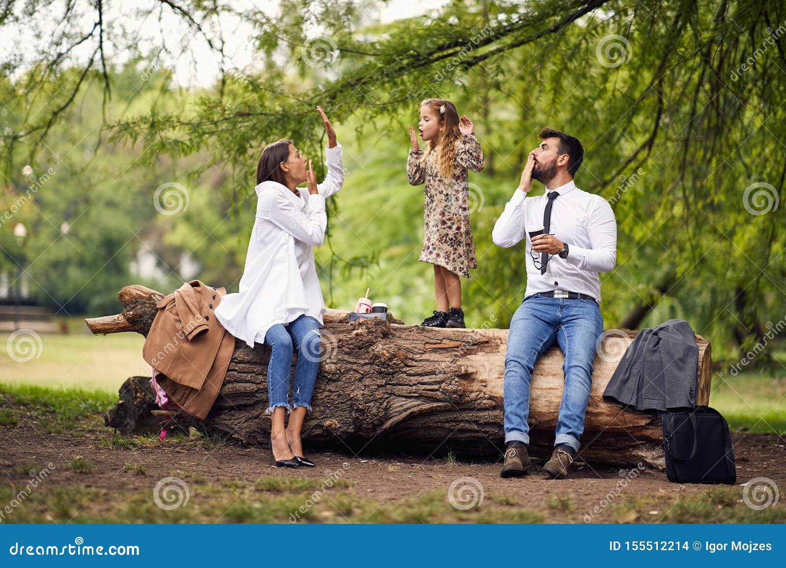 Family Having a Break in Park after School and Work Stock Photo - Image ...