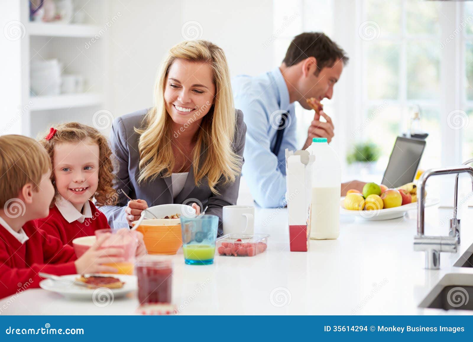 Family Having Breakfast in Kitchen before School and Work Stock Photo ...