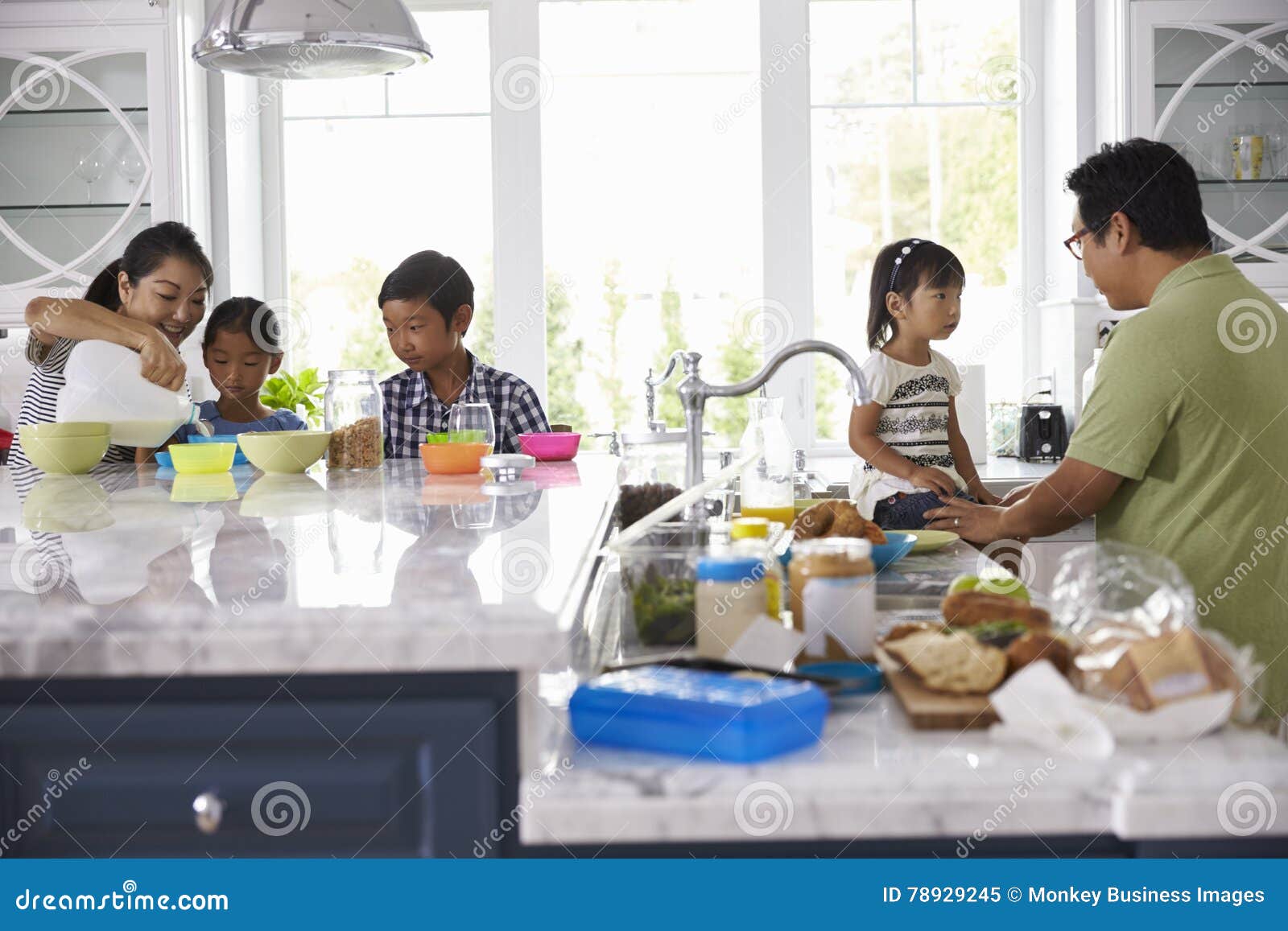 Family Having Breakfast and Making Lunches in Kitchen Stock Image ...