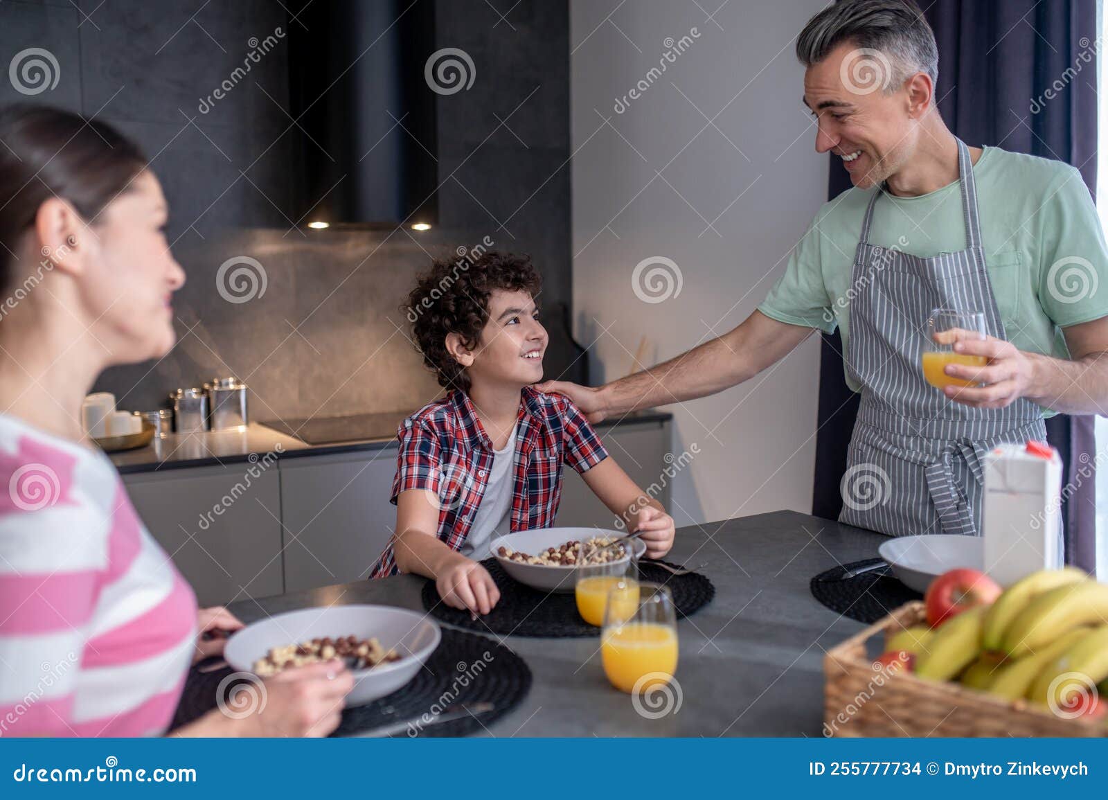 Family Having Breakfast Together and Looking Happy Stock Photo - Image ...