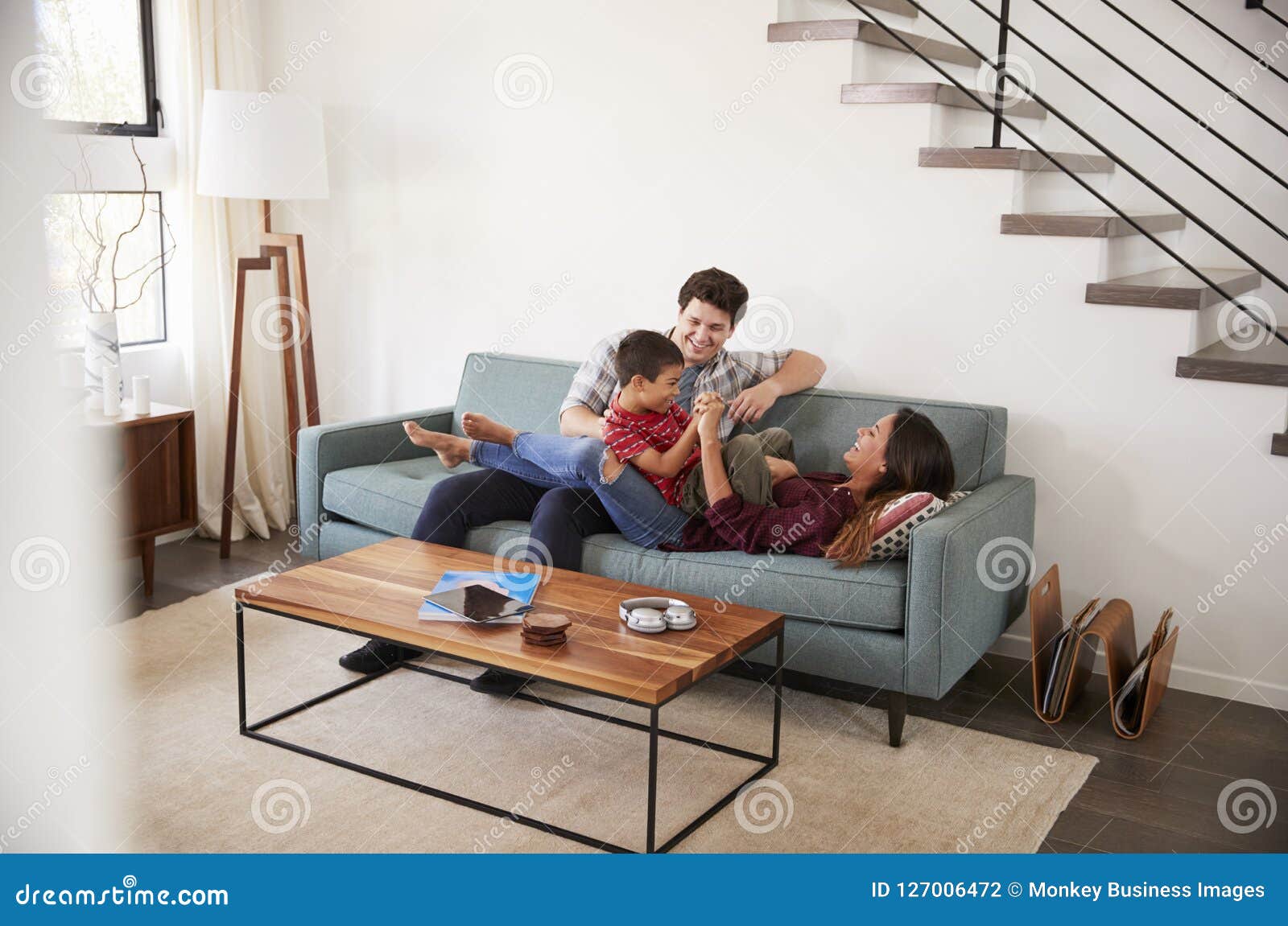 Family Having Fun Lying on Sofa at Home Together Stock Photo - Image of ...