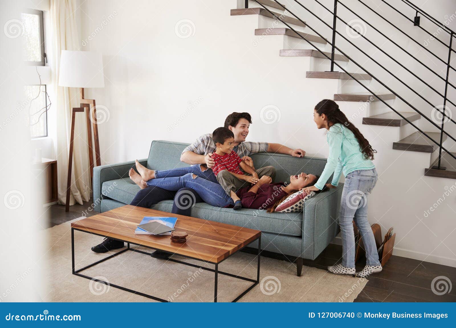 Family Having Fun Lying on Sofa at Home Together Stock Photo - Image of ...