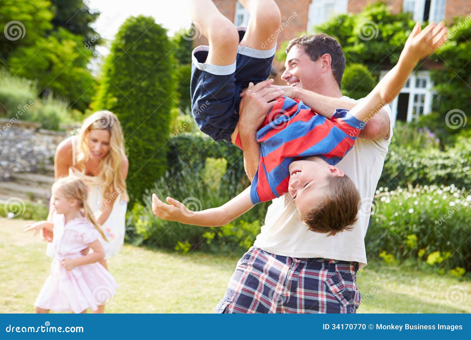 Family Having Fun Playing in Garden Stock Photo - Image of parent ...