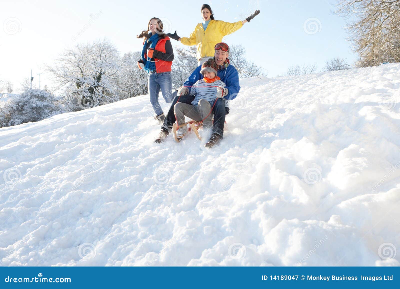 Family Having Fun Sledging Down Snowy Hill Stock Image - Image of ...