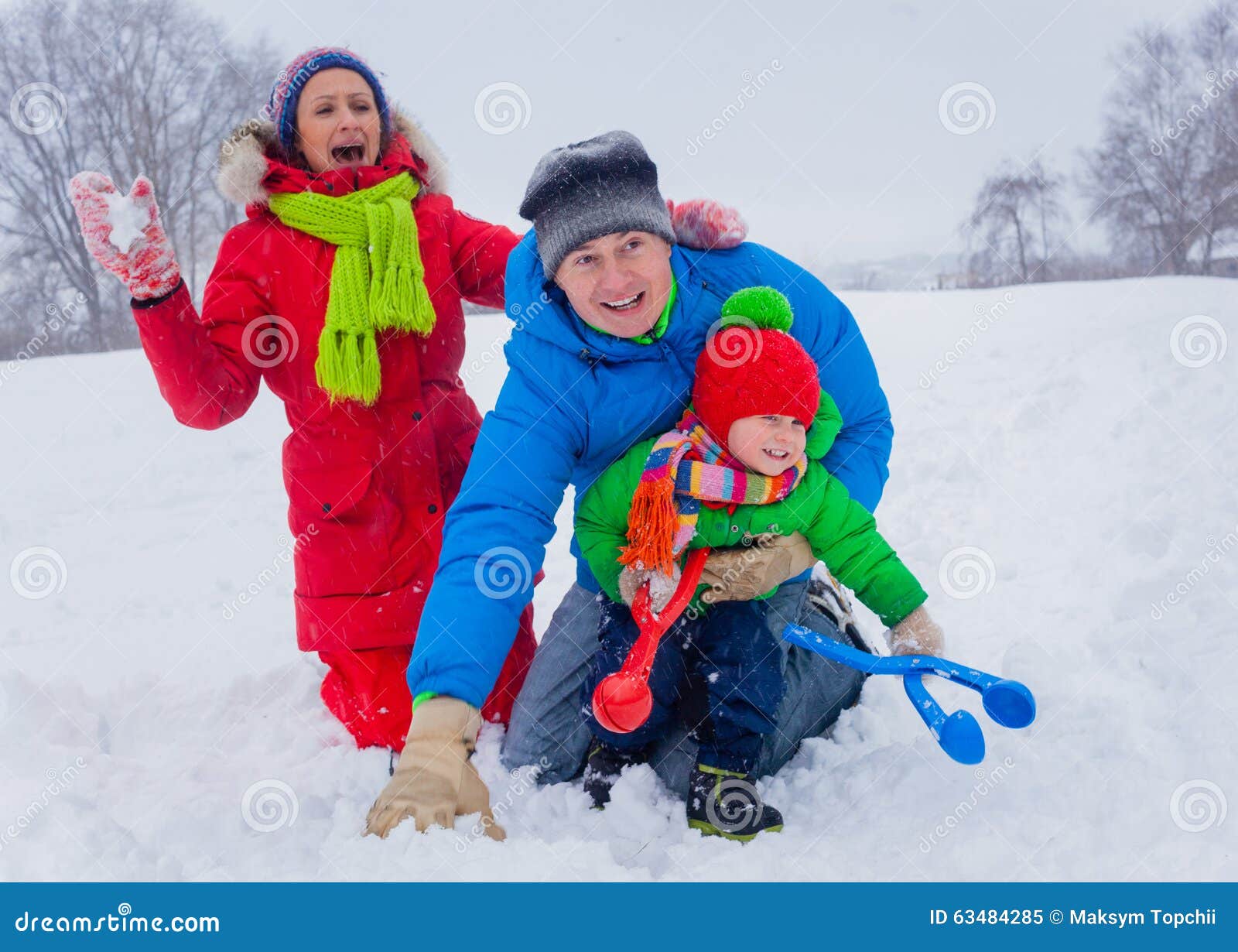 Family having fun in snow stock image. Image of cute - 63484285