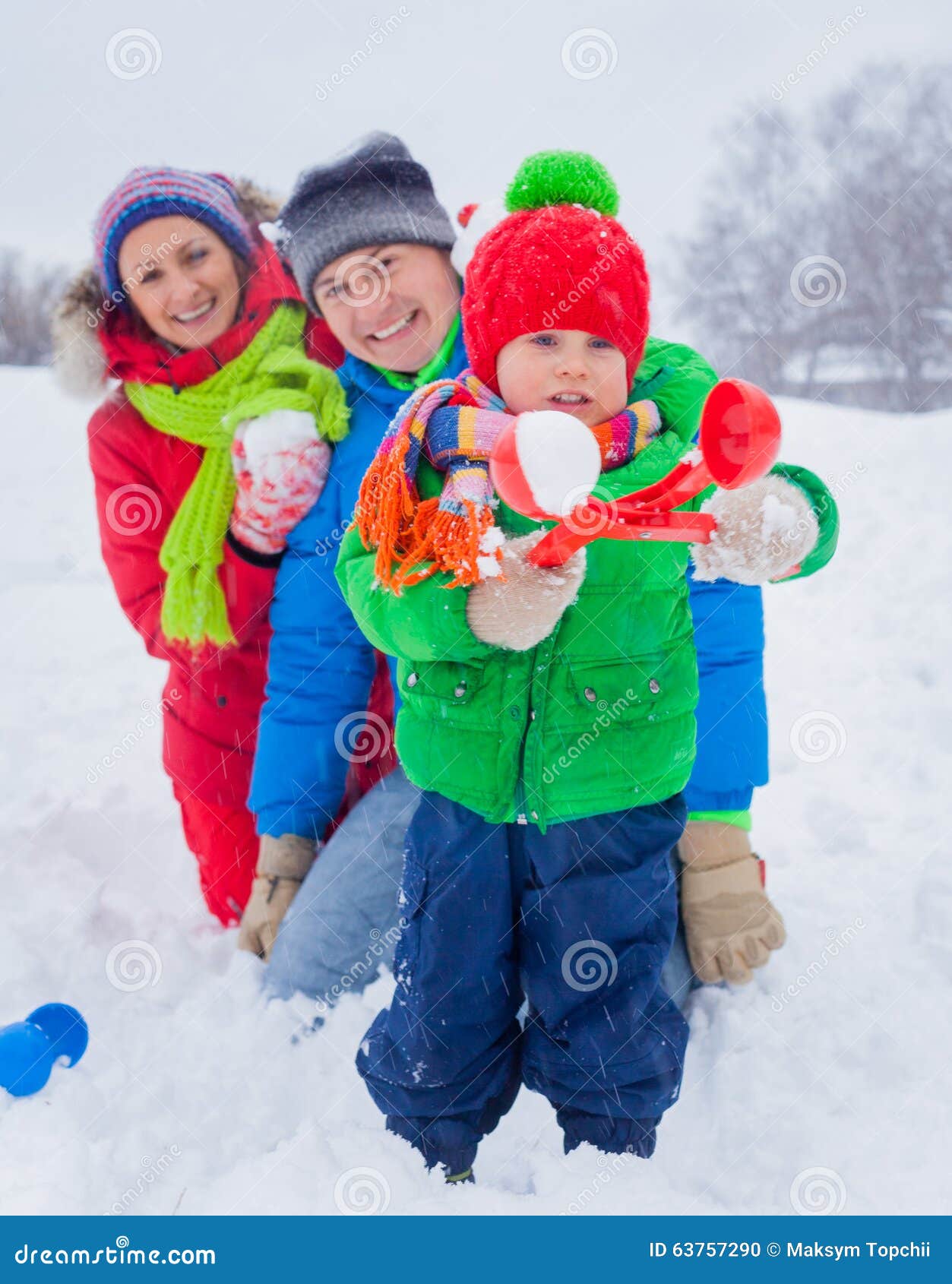 Family having fun in snow stock photo. Image of parents - 63757290