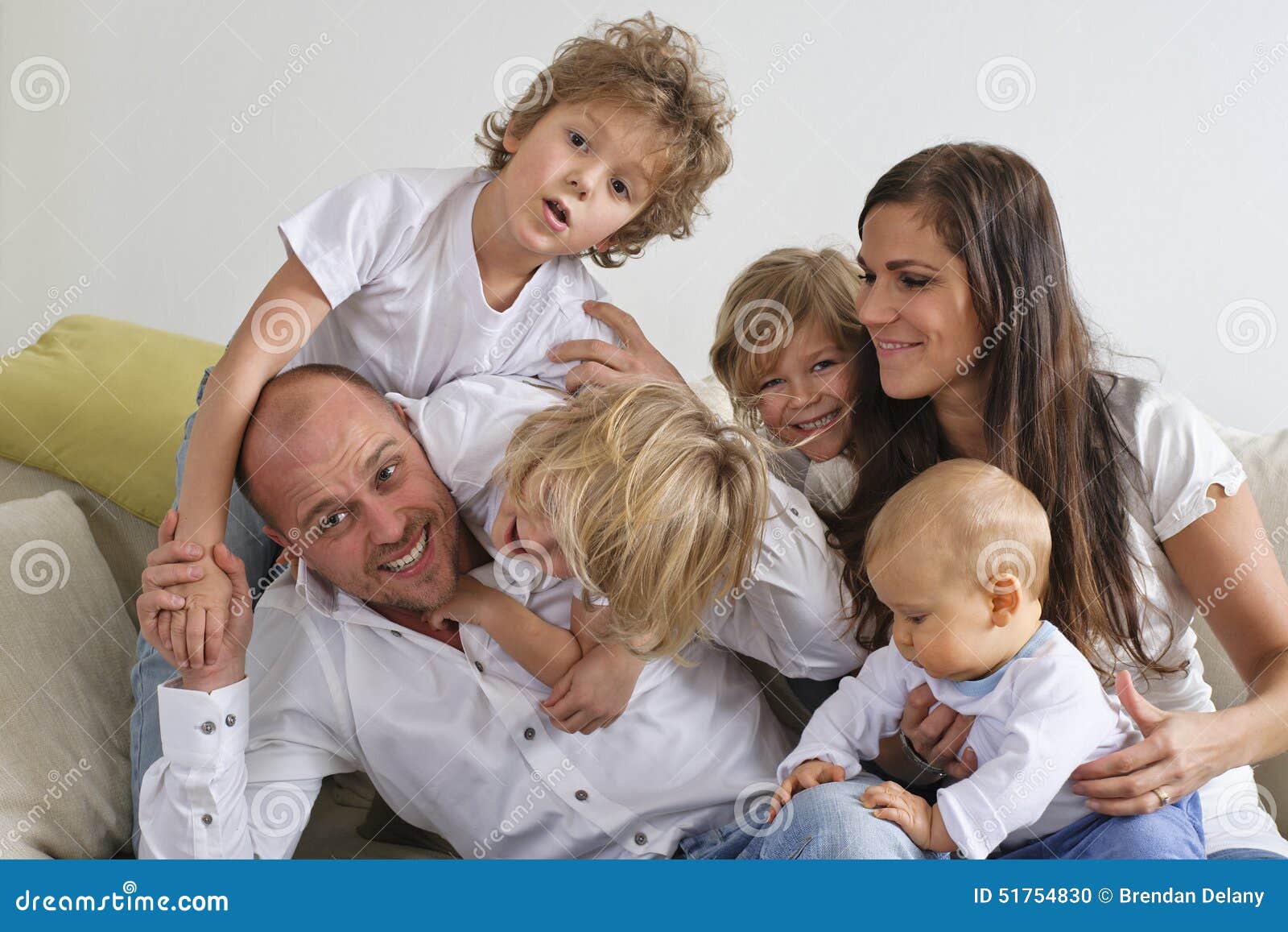 Family having fun on sofa stock photo. Image of looking - 51754830