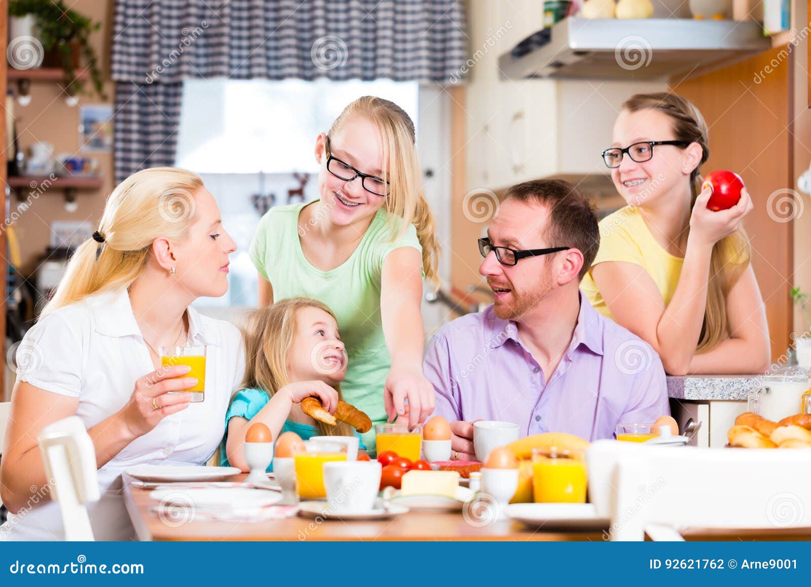 Family Having Joint Breakfast in Kitchen Stock Photo - Image of family ...