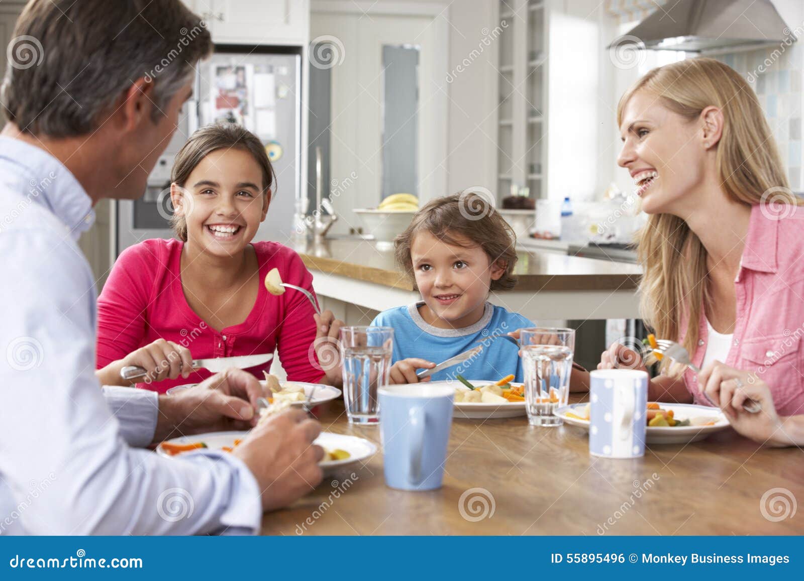 Family Having Meal in Kitchen Together Stock Photo - Image of brother ...