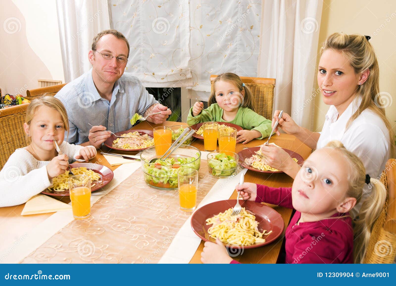 Family Having a Meal Together Stock Photo - Image of pasta, woman: 12309904