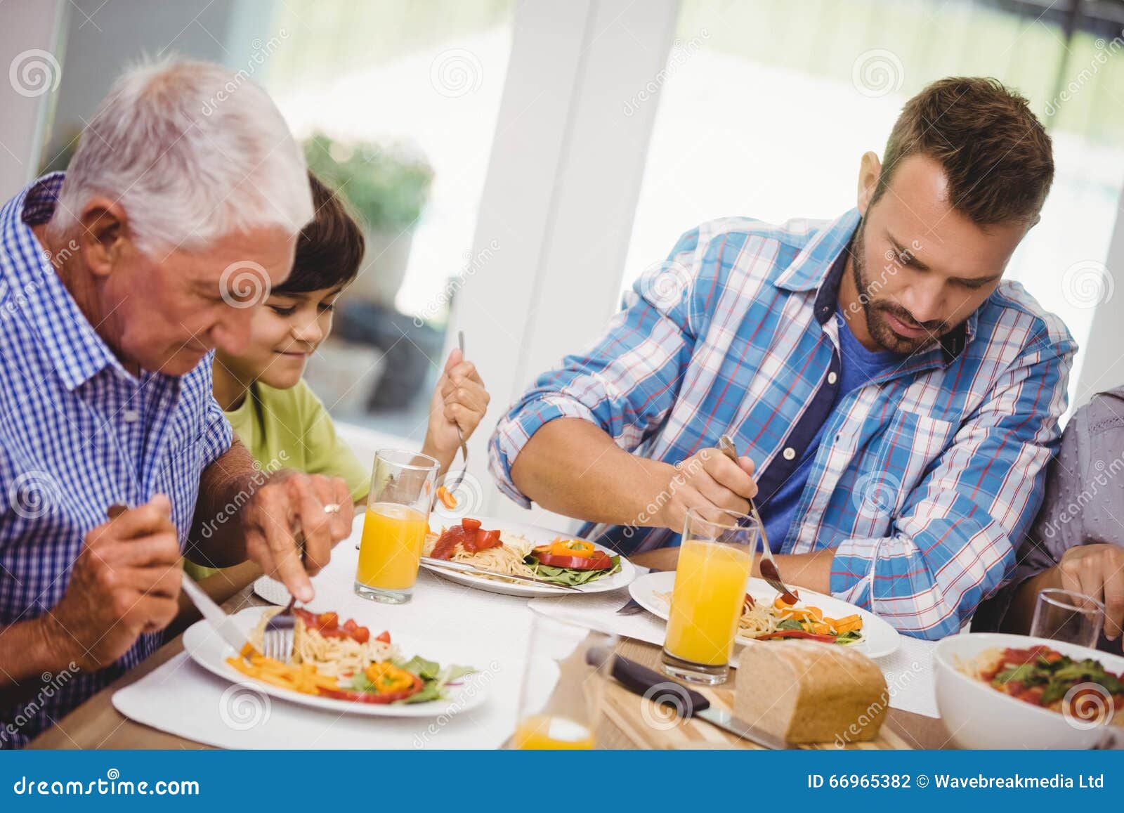 Family Having a Meal Together Stock Photo - Image of food, house: 66965382