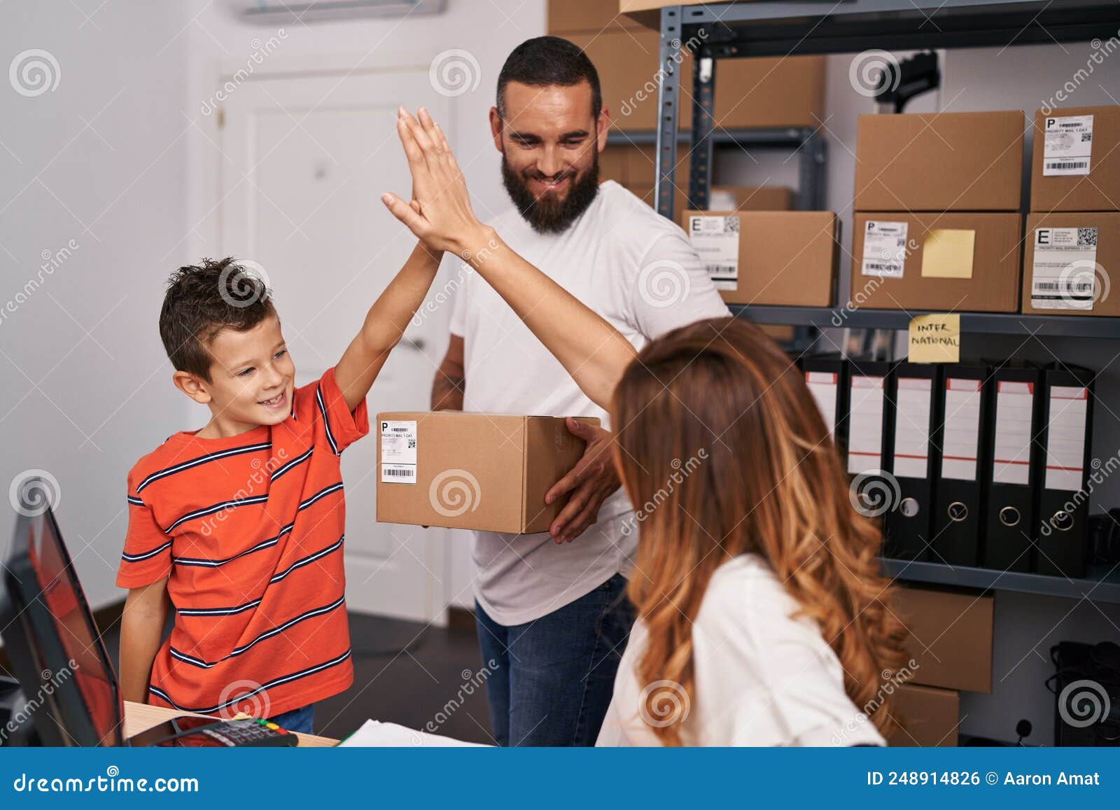 Family High Five with Hands Raised Up Working at Storehouse Stock Photo ...