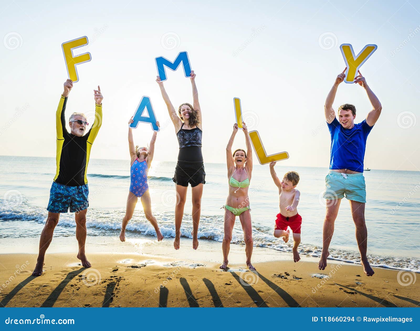 Family Holding Up Letters at the Beach Stock Photo - Image of group ...